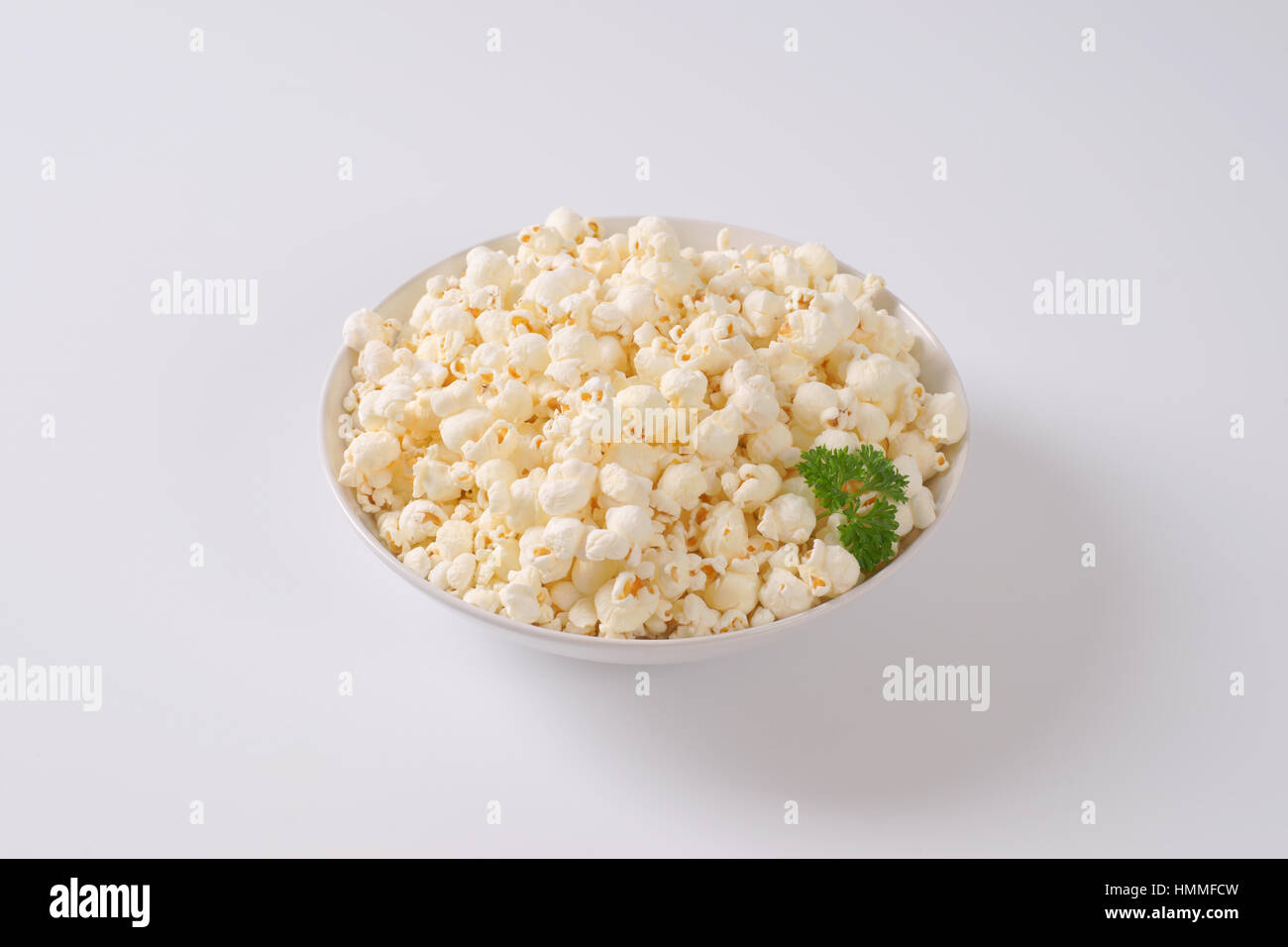 bowl of fresh popcorn on off-white background with shadows Stock Photo ...
