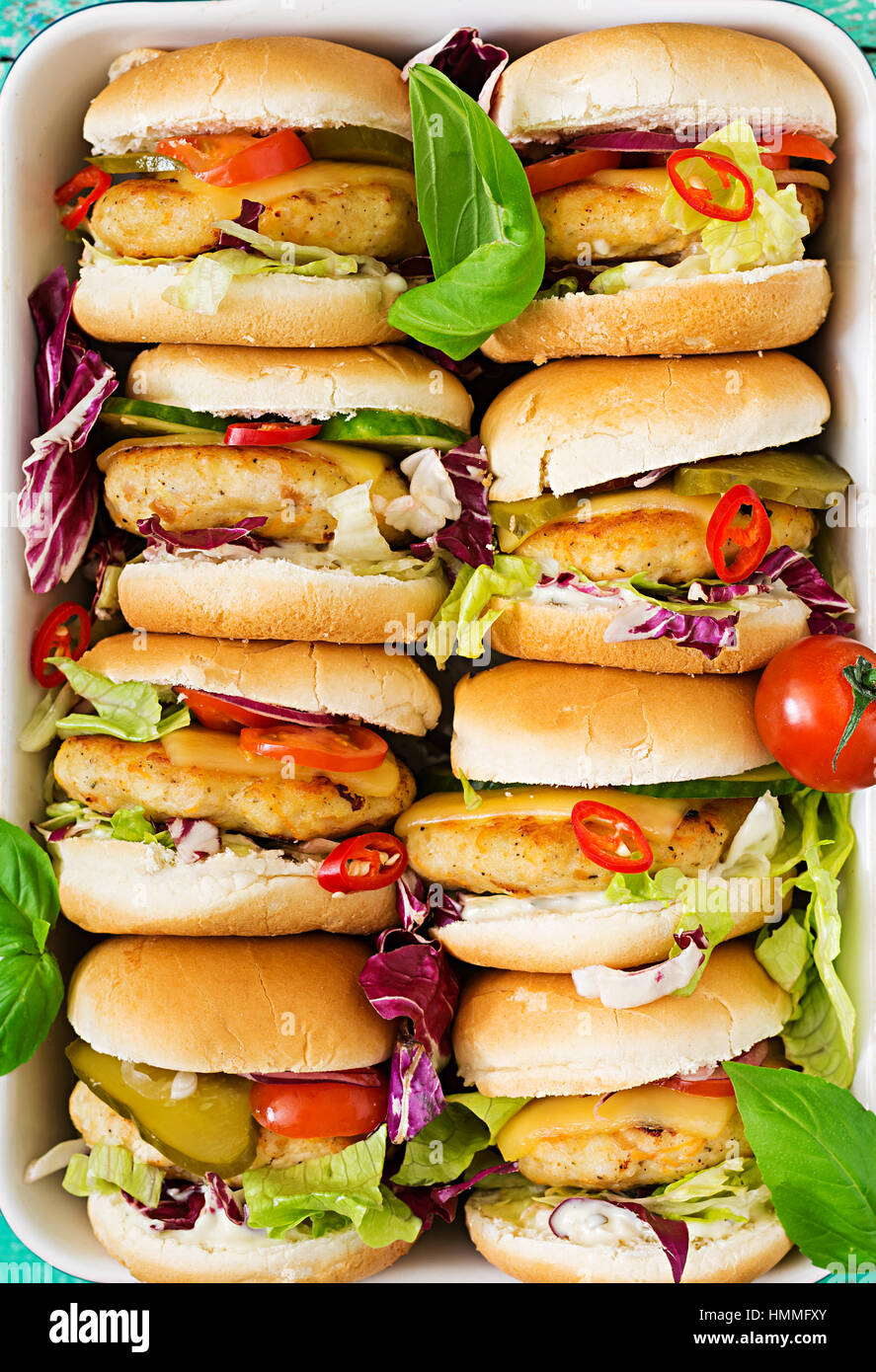 Mini hamburgers with chicken burger, cheese and a vegetables. Flat lay ...