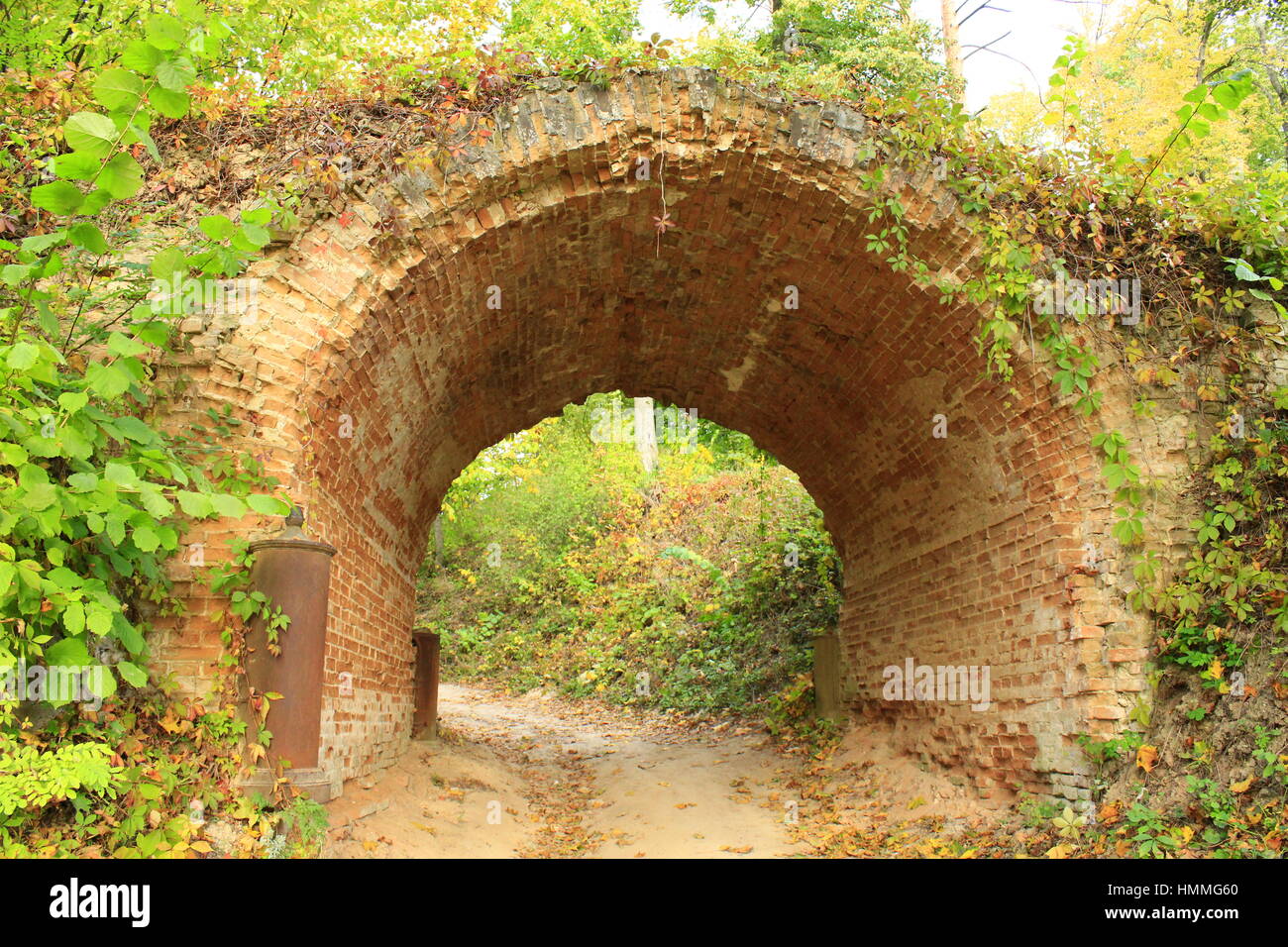 sandy road under historical arch from ed bricks in Kachanivka park ...