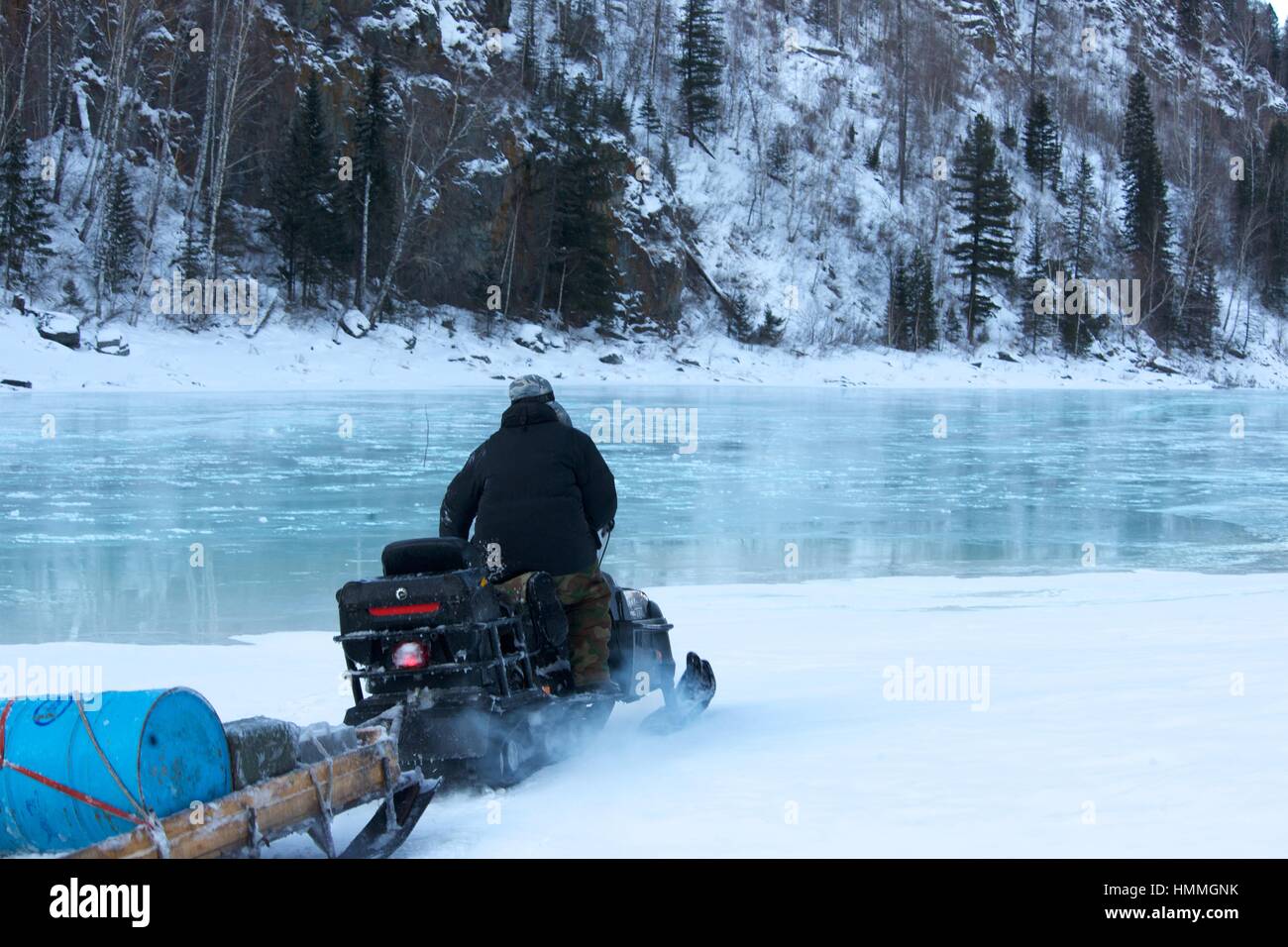 Man riding on a snowmobile frozen water Stock Photo - Alamy Man riding on a snowmobile frozen water Stock Photo - Alamy