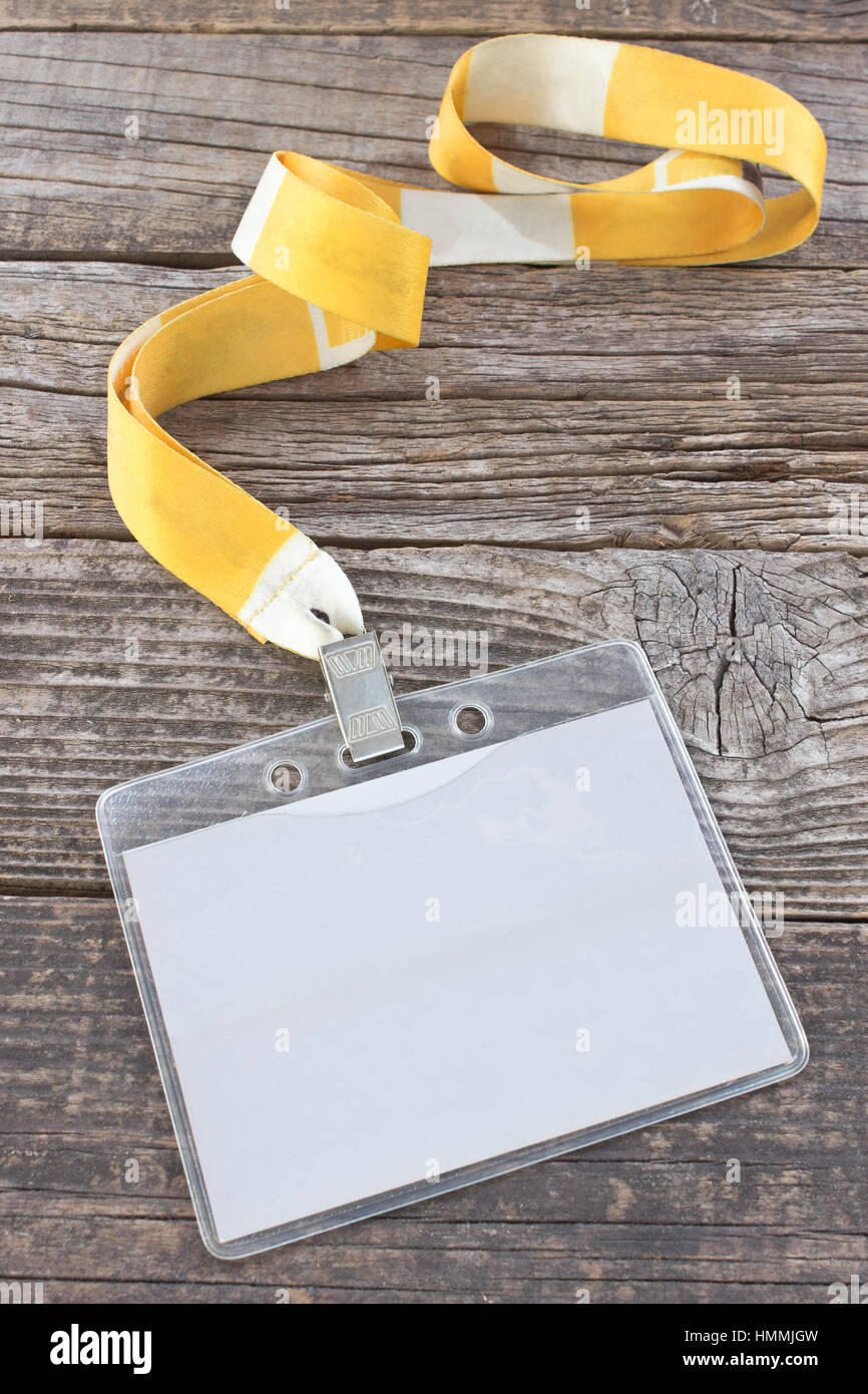 Blank ID card tag and yellow ribbon on wooden background Stock Photo ...