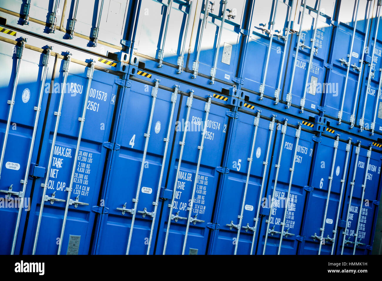 Blue shipping containers stacked waiting transport Stock Photo - Alamy