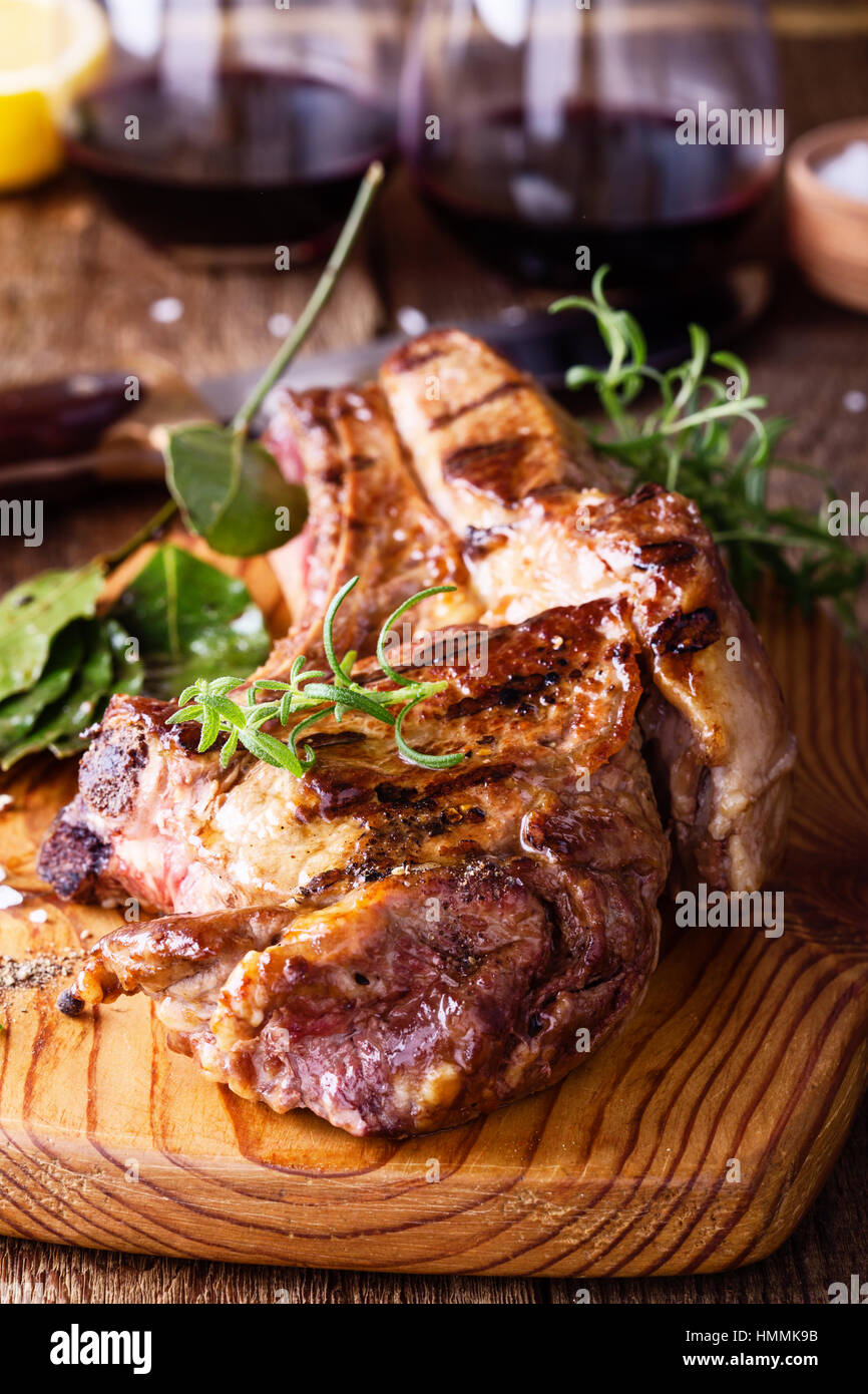 Barbecue bone ribeye steak on rustic cutting board ready to eat ...