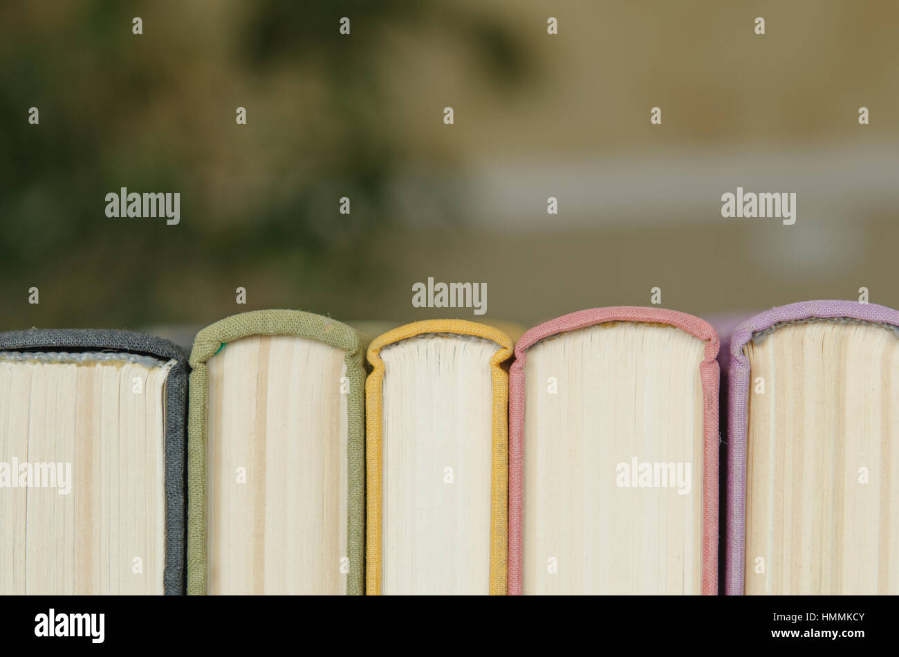 a stack of colorful books in a library or a room Stock Photo - Alamy