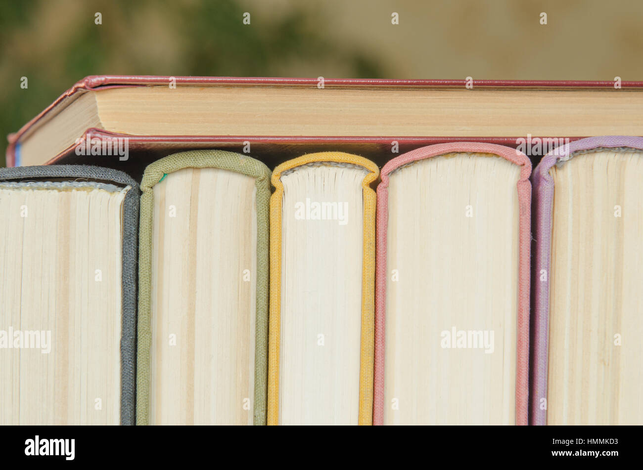 a stack of colorful books in a library or a room Stock Photo - Alamy