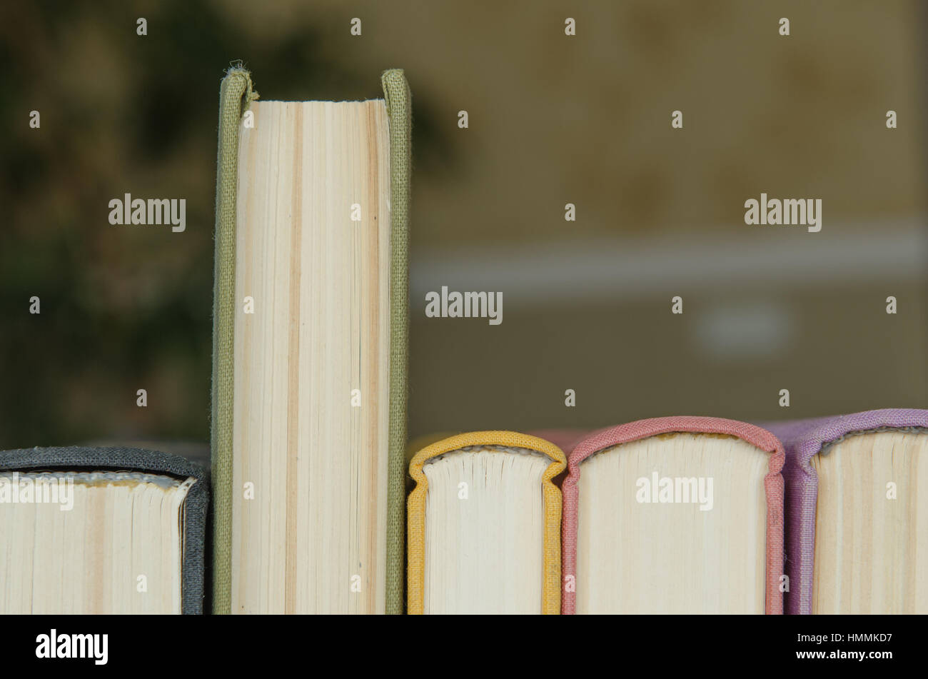 a stack of colorful books in a library or a room Stock Photo - Alamy