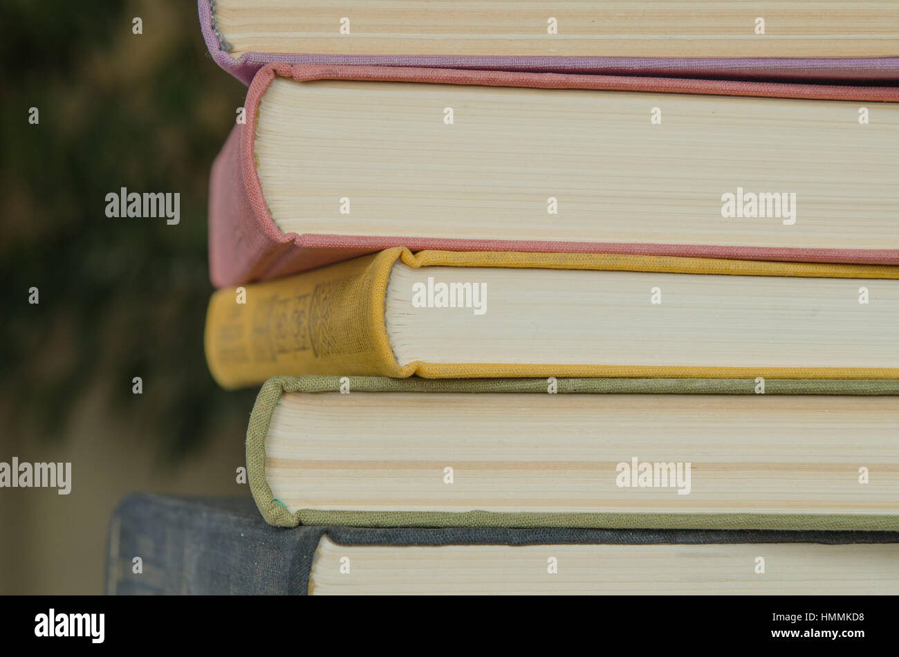 a stack of colorful books in a library or a room Stock Photo - Alamy