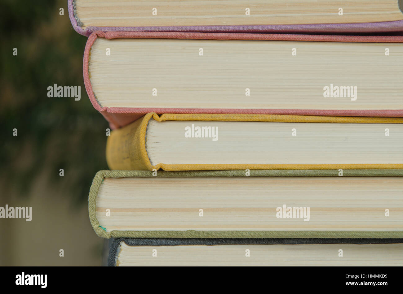 a stack of colorful books in a library or a room Stock Photo - Alamy