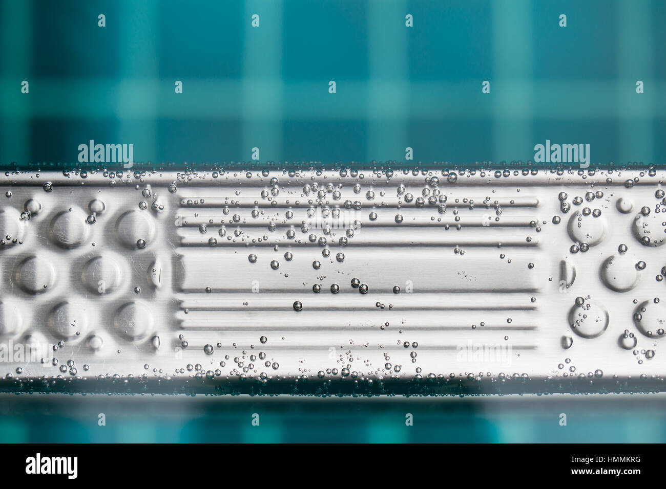 closeup small clear water bubble at metal pool ladder in the swimming ...