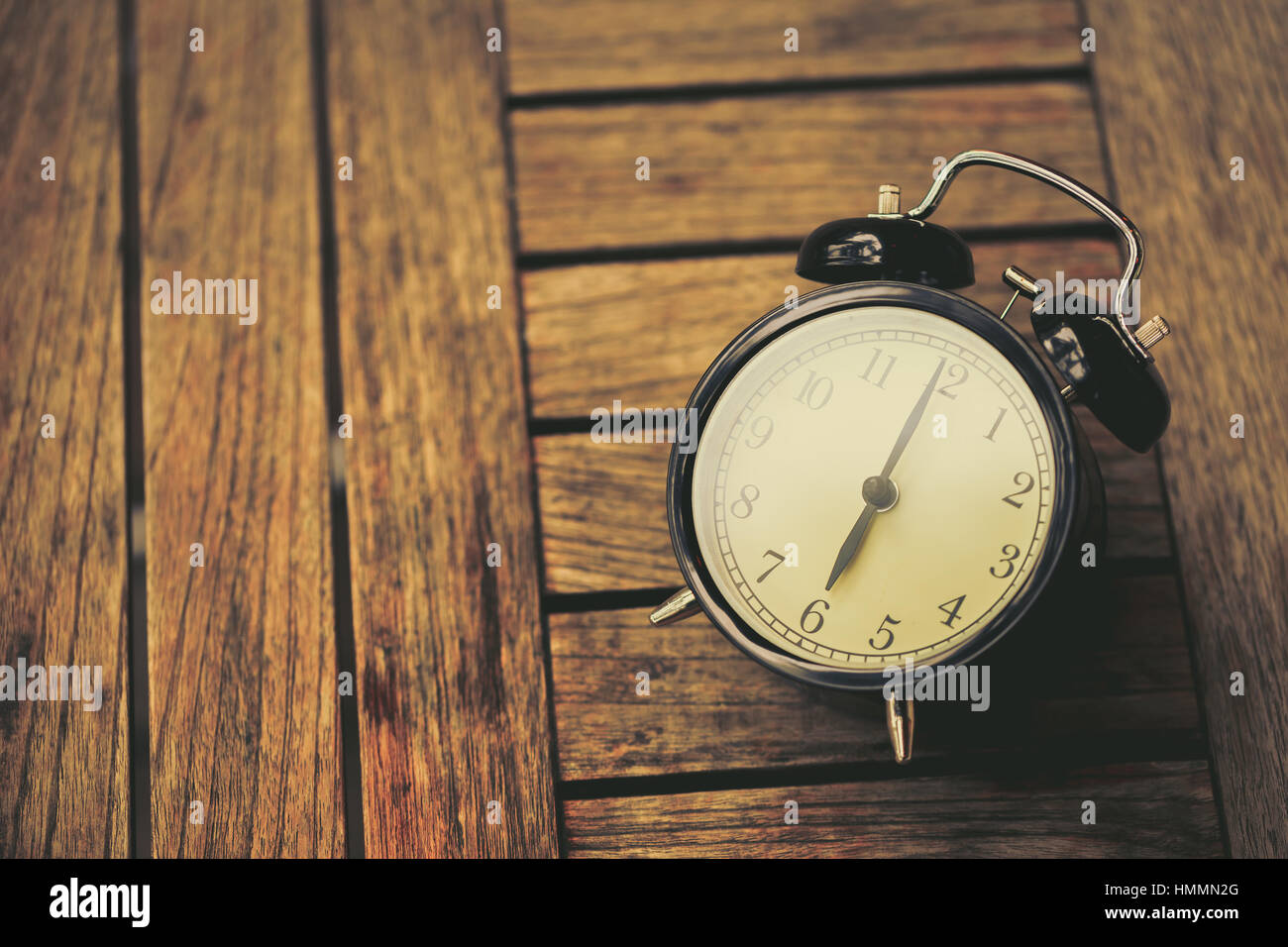 old clock at 6 o'clock on wooden table vintage color tone Stock Photo ...