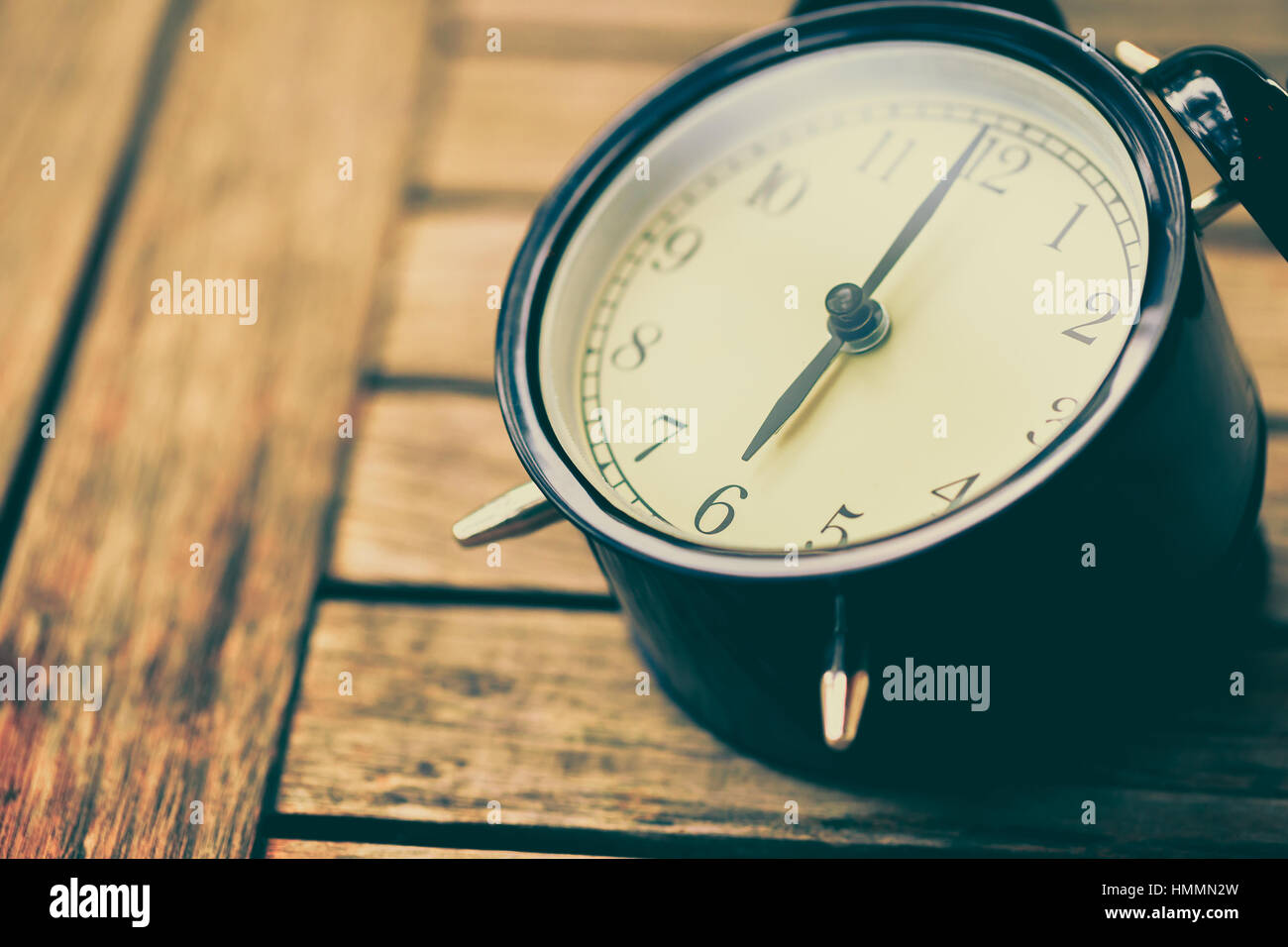 old clock at 6 o'clock on wooden table vintage color tone Stock Photo ...