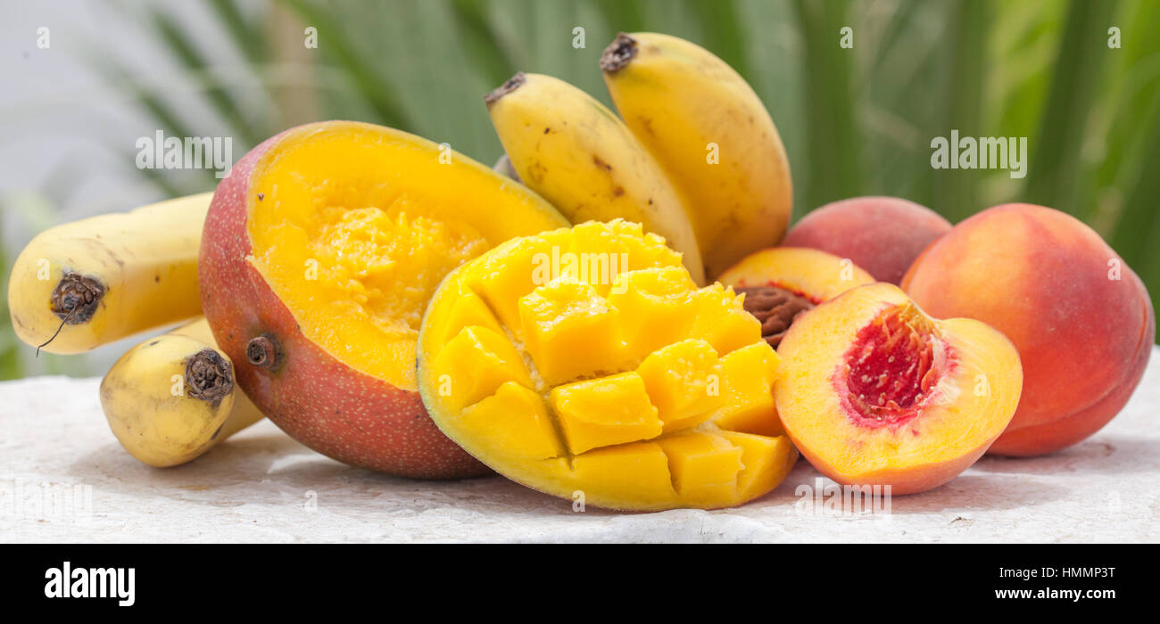 tropical fruits mango, peach and banana Stock Photo - Alamy