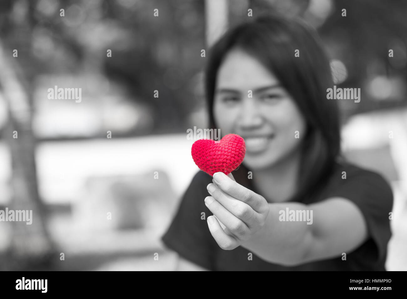Giving love, Asian teen smile give red heart Stock Photo - Alamy
