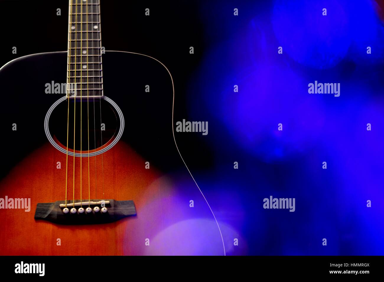 acoustic guitar with blue background Stock Photo - Alamy