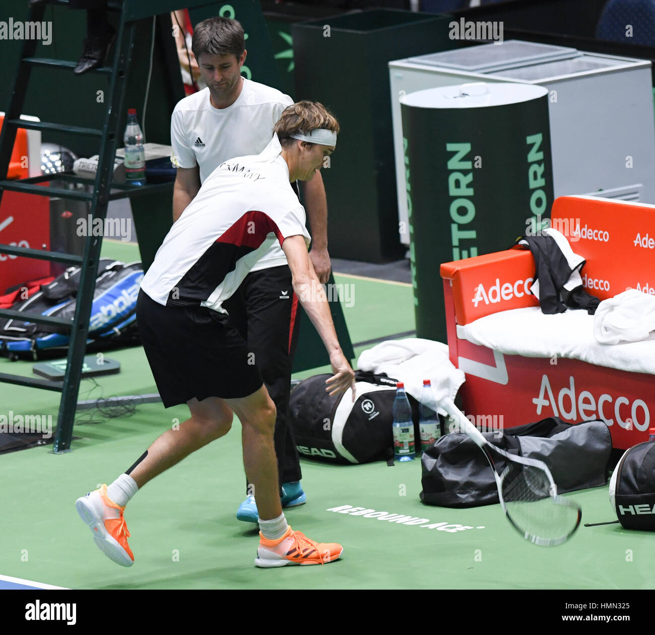 German tennis player Alexander Zverev (front) throws his racket to the ...