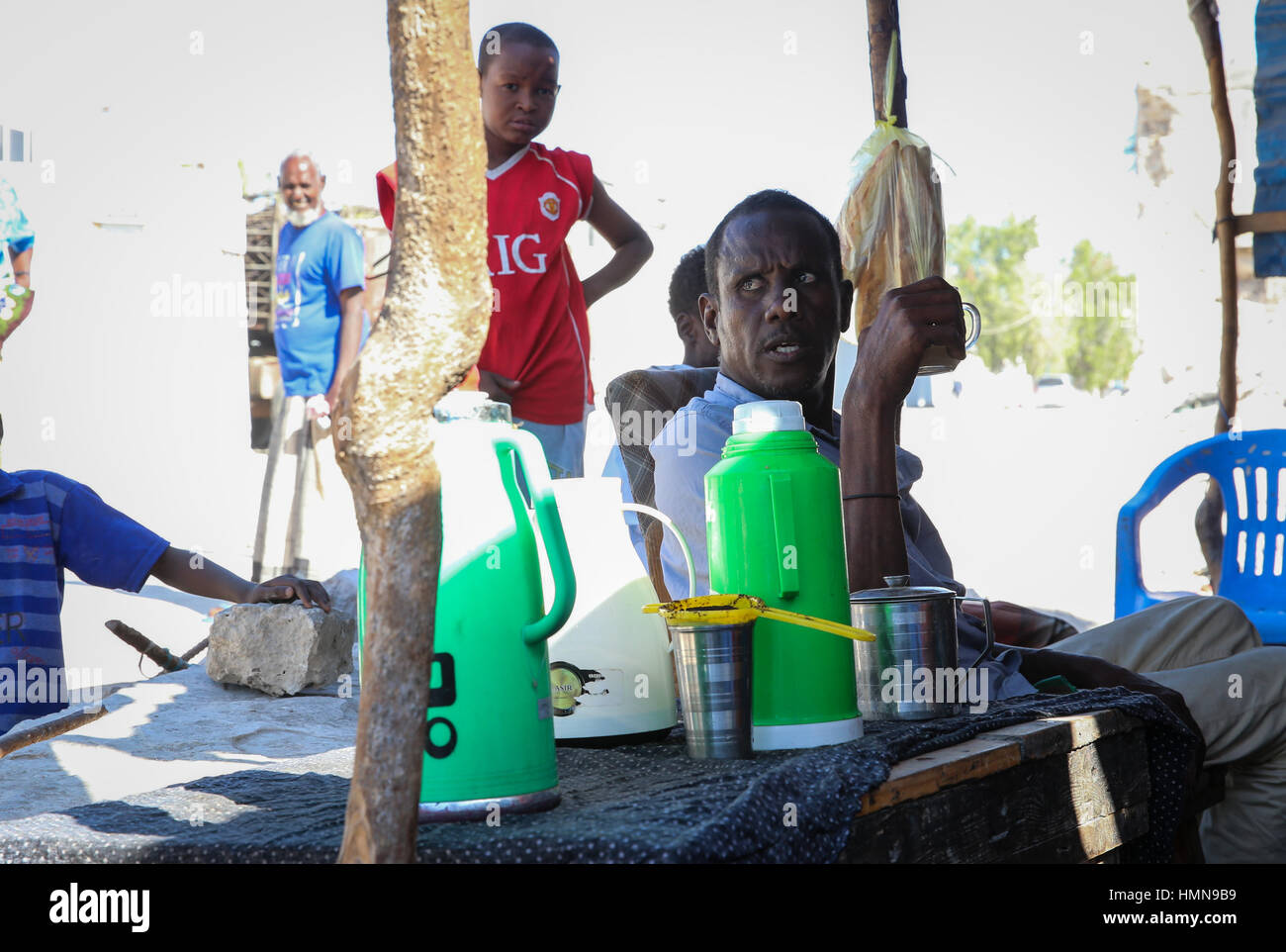 Mogadishu, Somalia. 10th Feb, 2017. A man drinks tea at a roadside shop ...