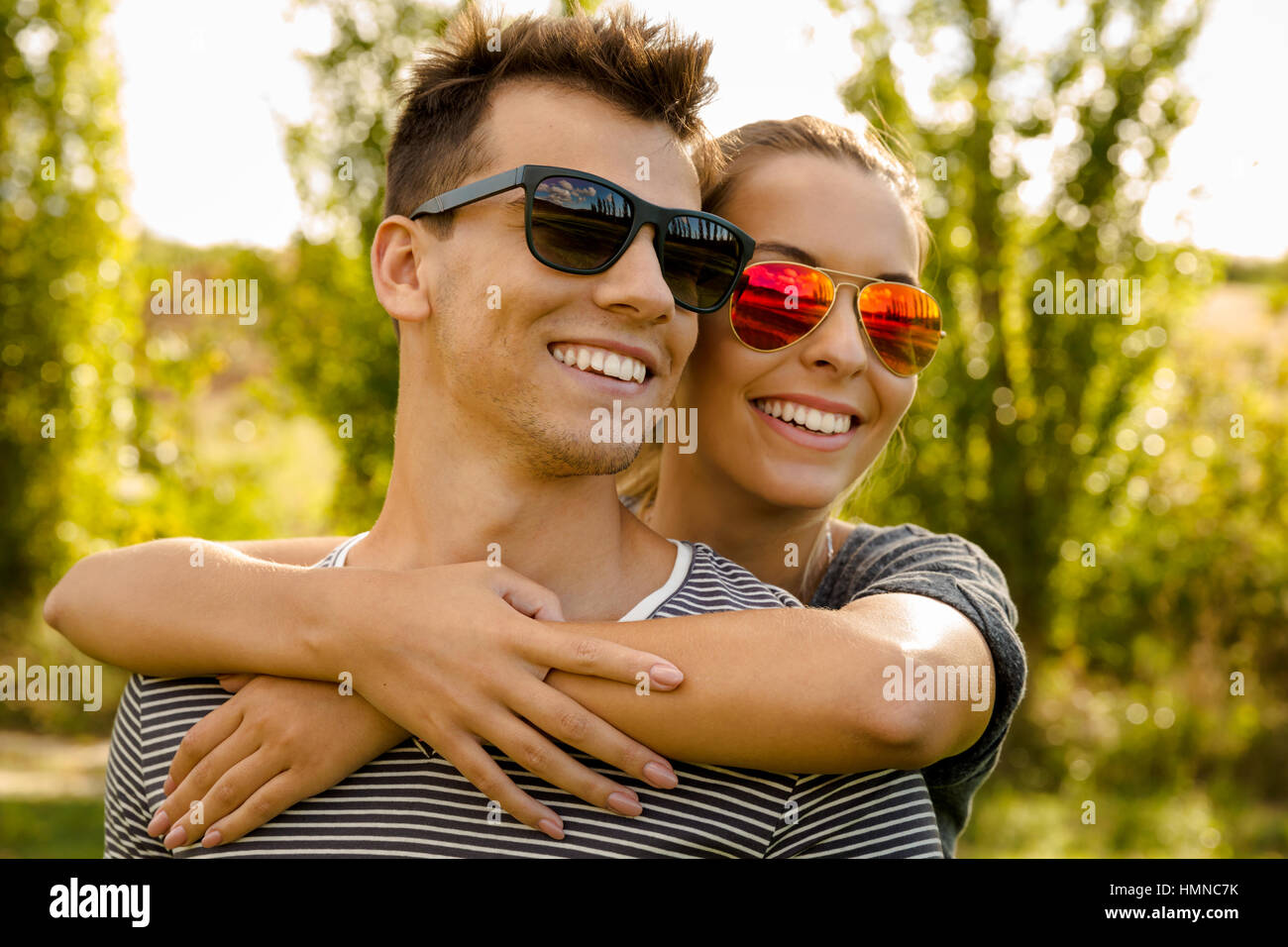 Portrait of a happy young couple embraced Stock Photo - Alamy