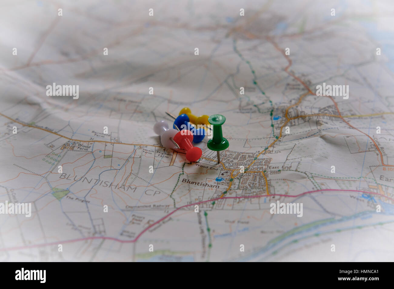 Close-up image of coloured pins seen on a hiking and trail paper map ...