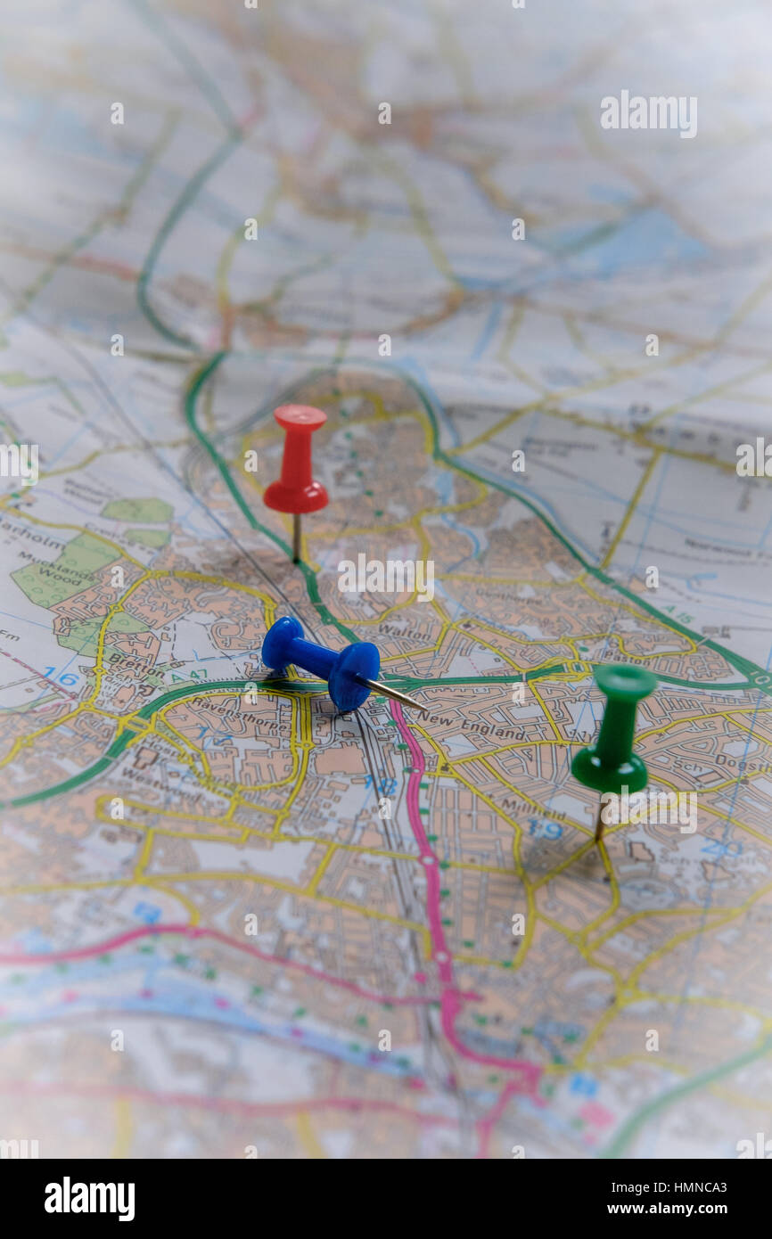 Close-up image of coloured pins seen on a hiking and trail paper map ...