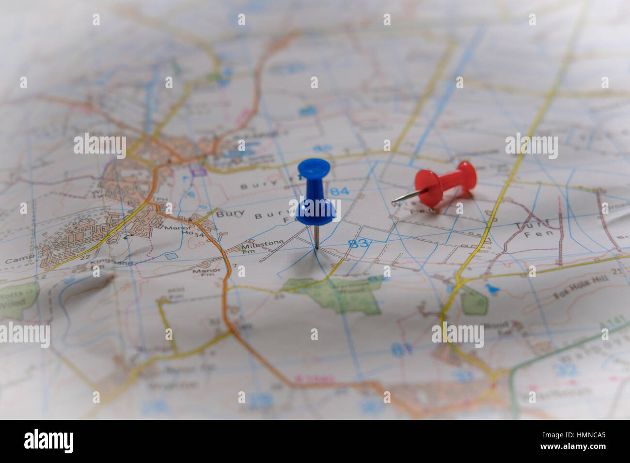 Close-up image of coloured pins seen on a hiking and trail paper map ...