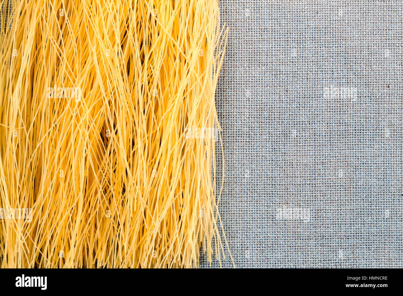 Bavette pasta spaghetti on a burlap cloth with a dark background with ...