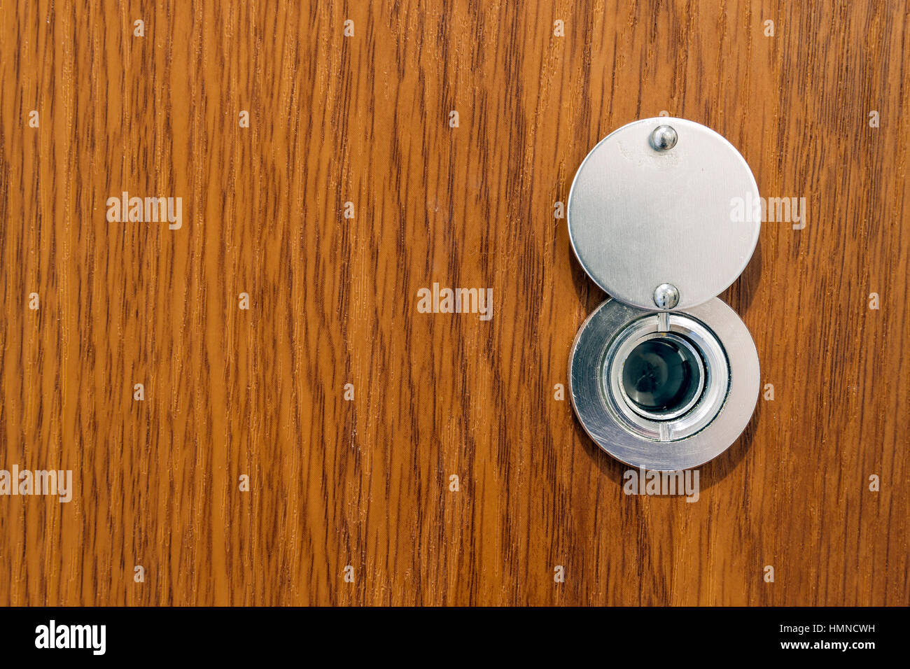 Lens peephole on new wooden texture front door Stock Photo - Alamy