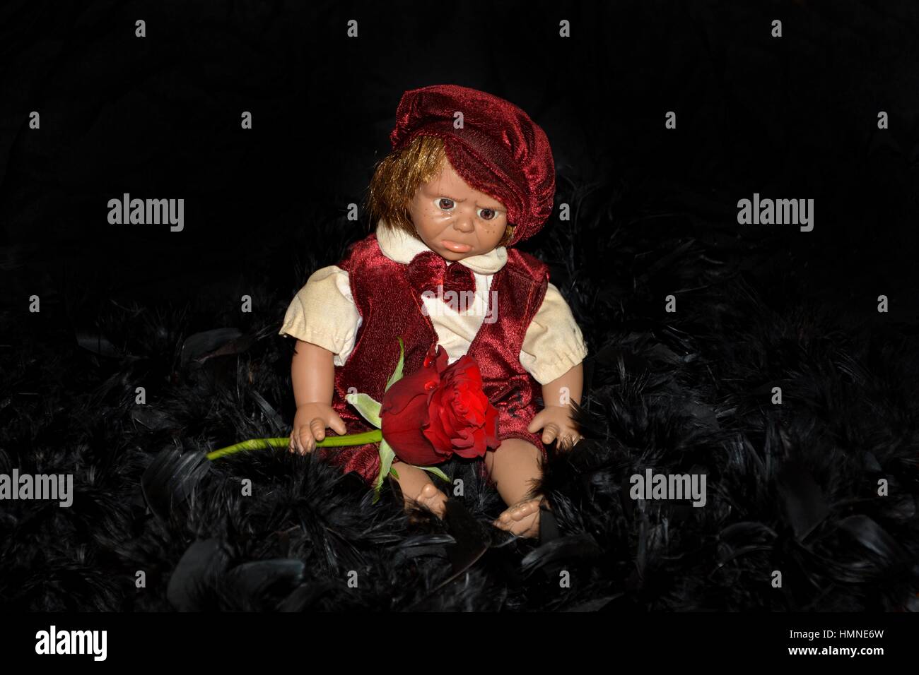 Of sadness dolls - boy with tears and with red rose on black feathers ...