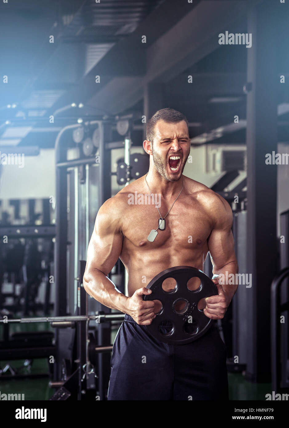 Young adult bodybuilder screaming in gym Stock Photo - Alamy