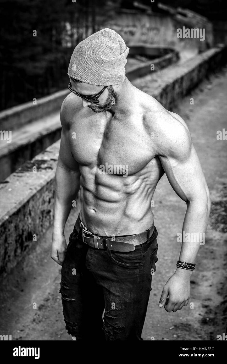 Stylish muscle man posing topless outdoor in urban fashion manner Stock ...