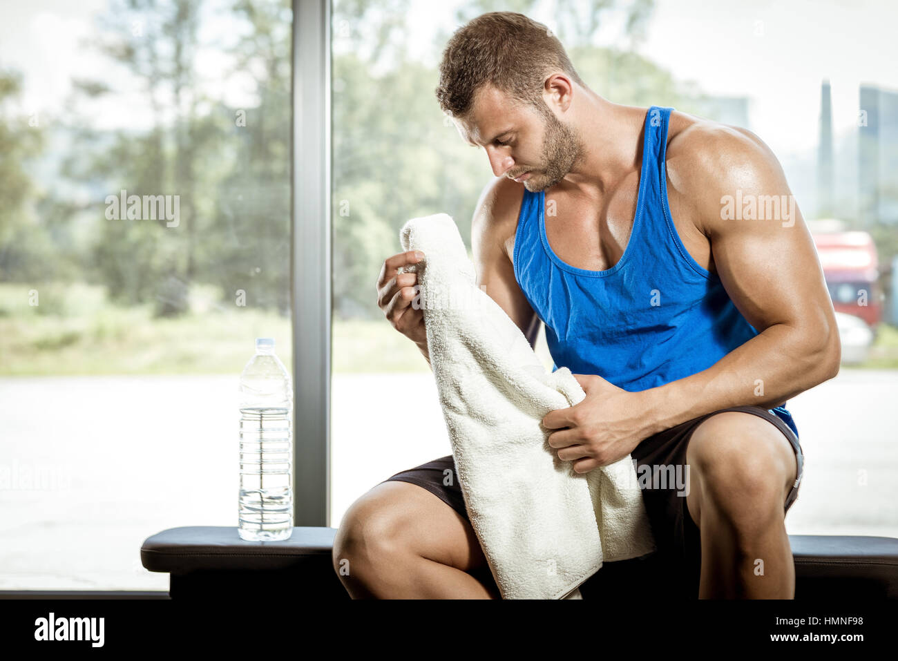 Young adult man relaxing after workout in gym Stock Photo - Alamy