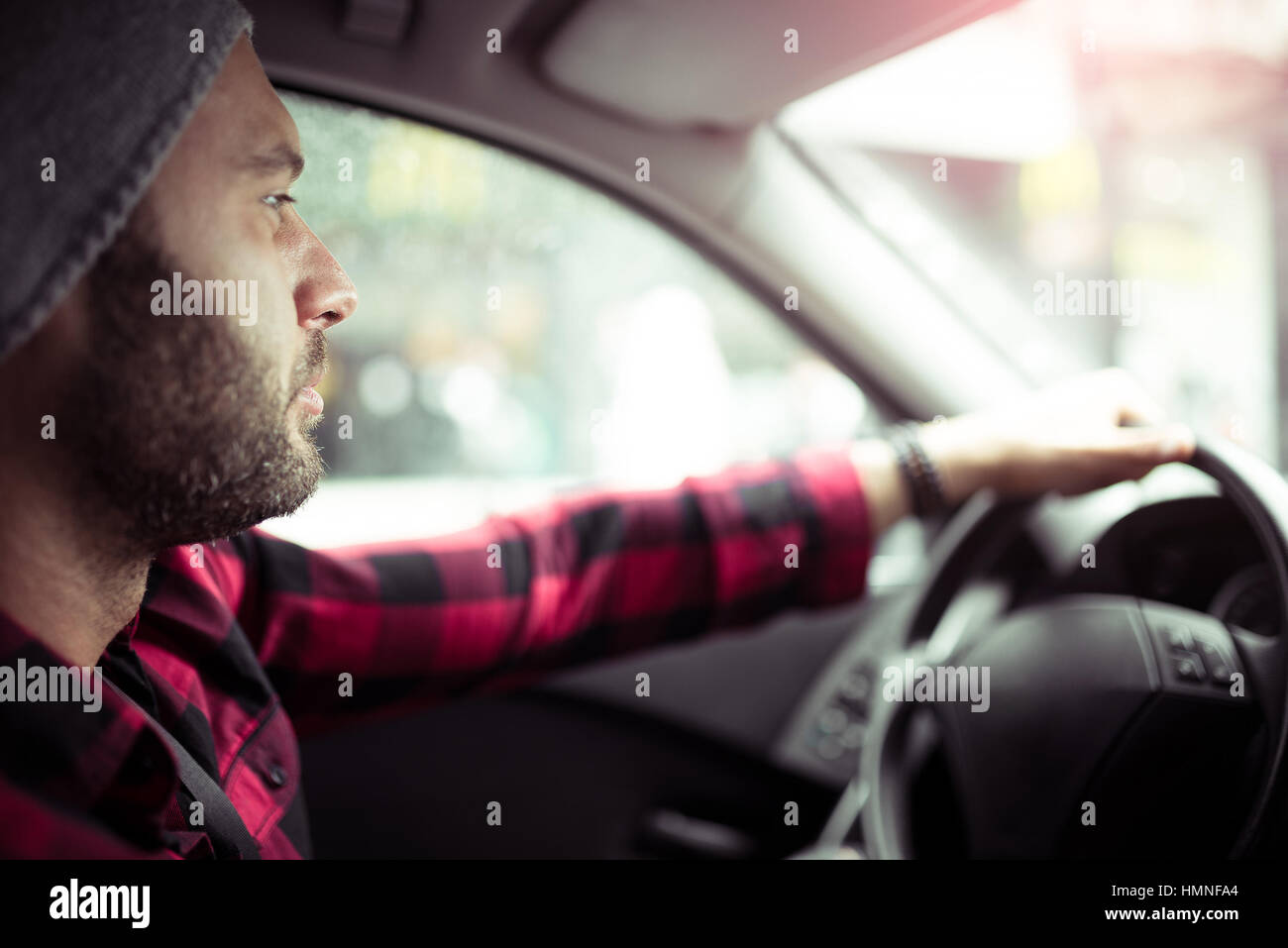 Handsome man driving luxury car wearing cap and sunglasses Stock Photo ...