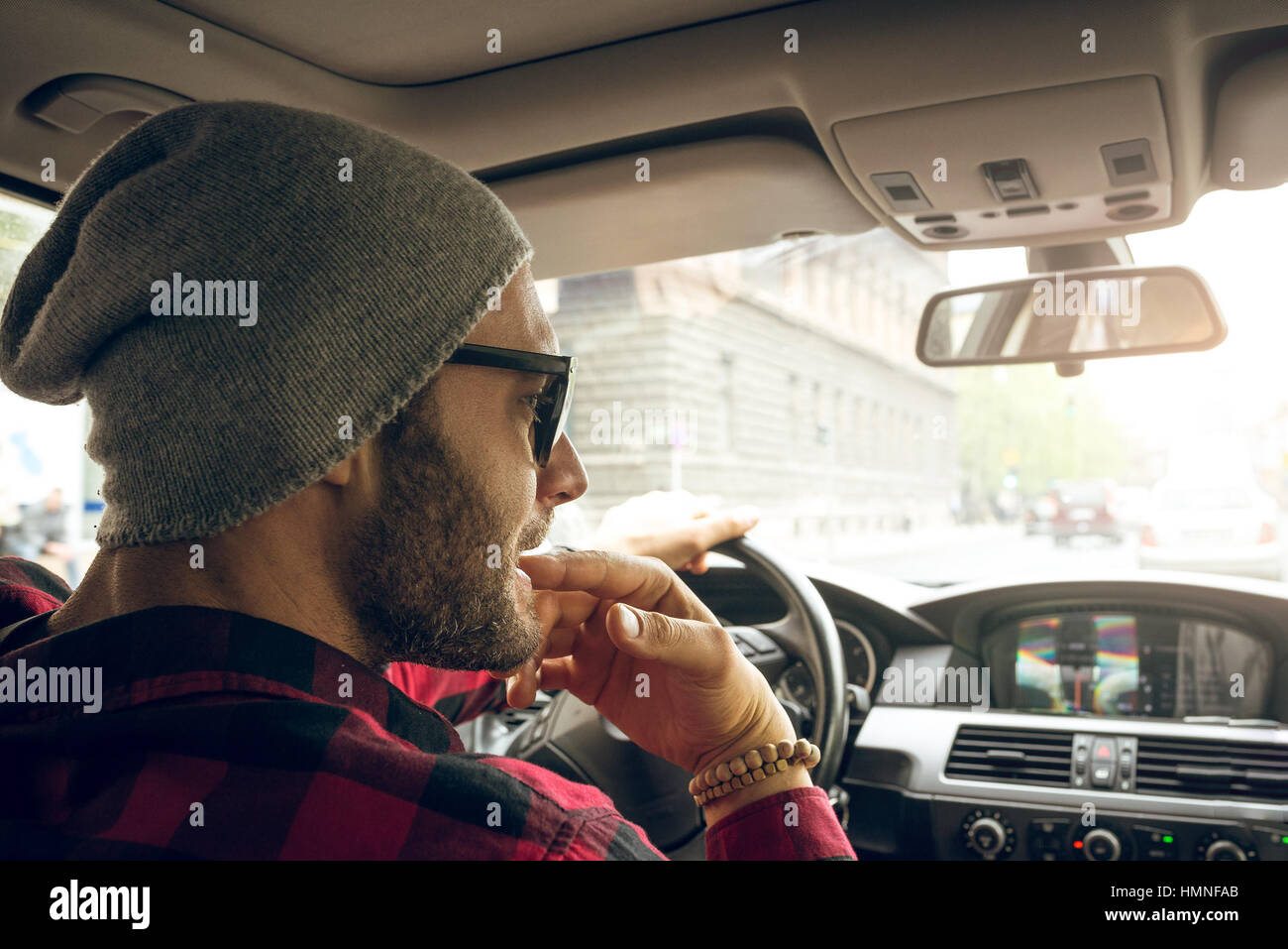 Handsome man driving luxury car wearing cap and sunglasses Stock Photo ...