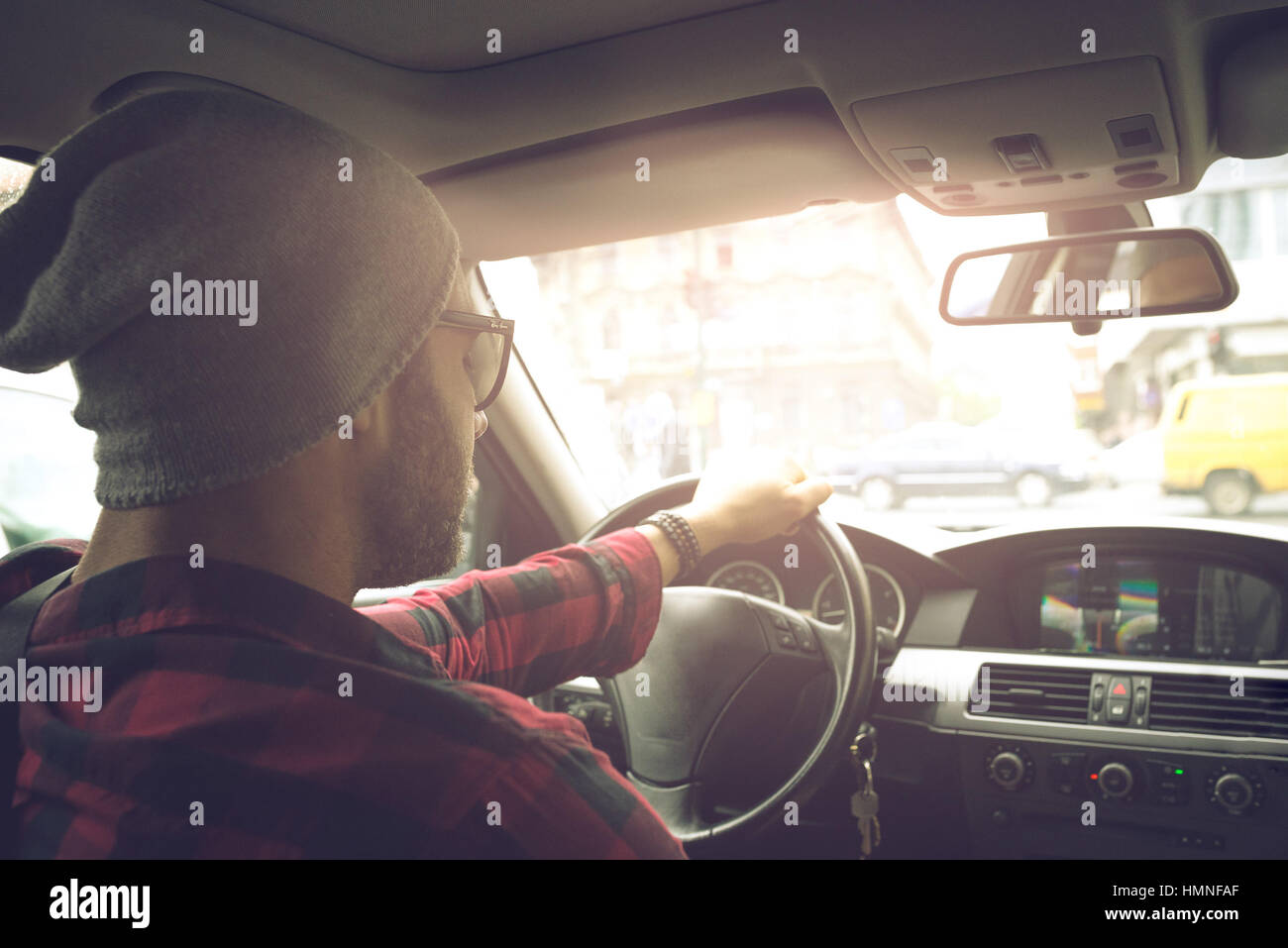 Handsome man driving luxury car wearing cap and sunglasses Stock Photo ...
