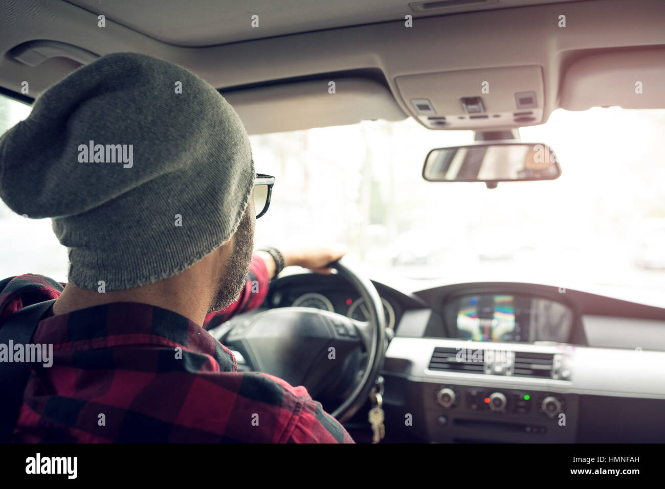 Handsome man driving luxury car wearing cap and sunglasses Stock Photo ...
