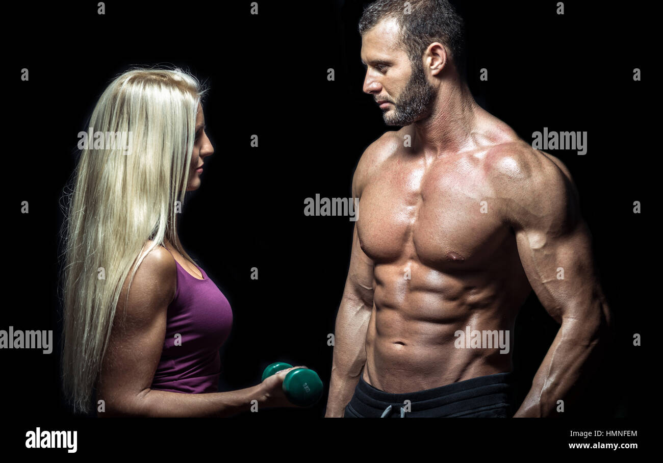 Attractive young adult fitness couple in 20s working out together doing ...