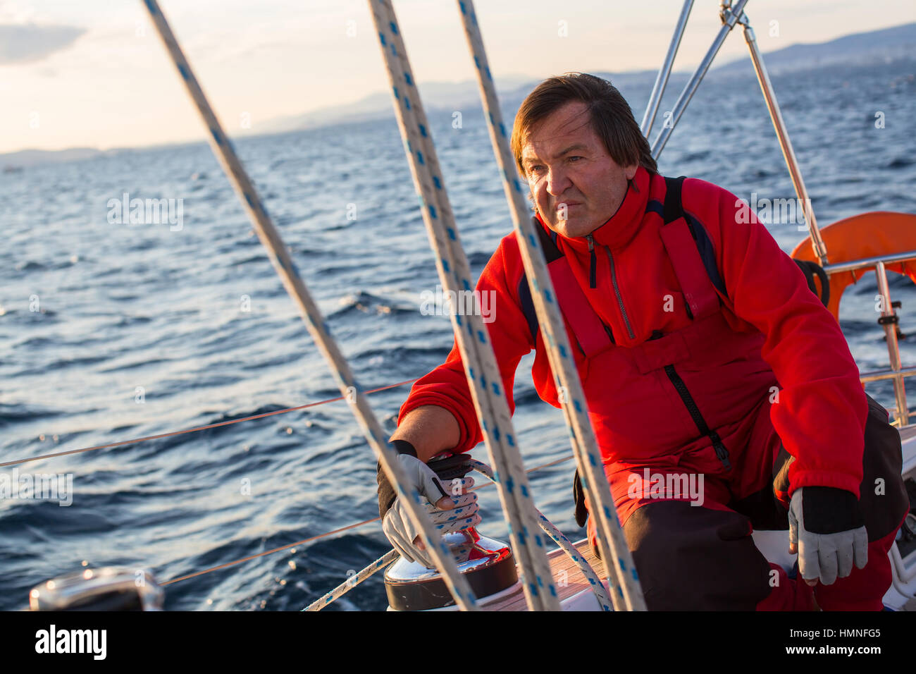 Mature male skipper sitting on his sailing yacht Stock Photo - Alamy