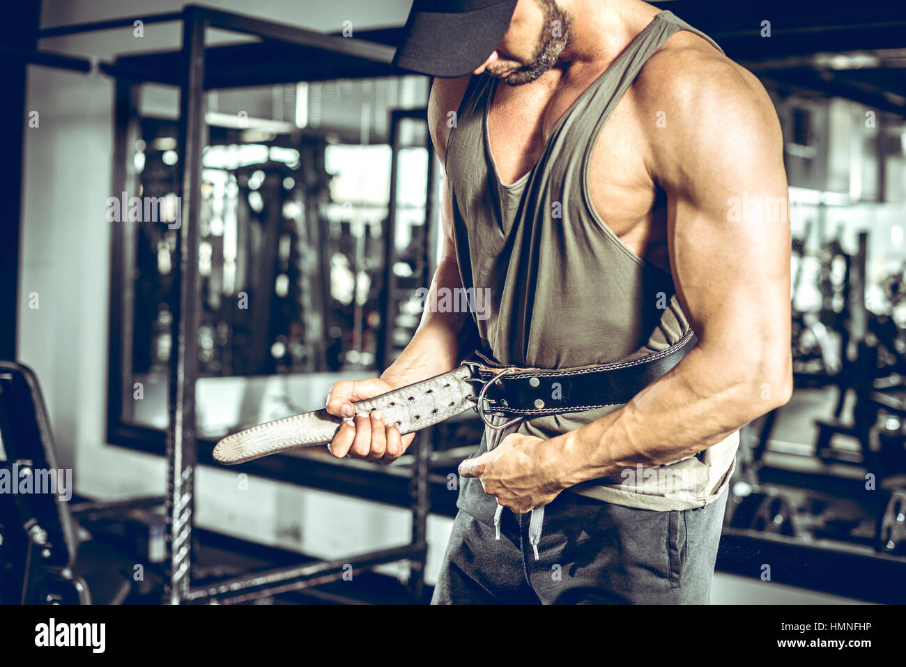 Adult bodybuilder wearing leather gym protection belt Stock Photo - Alamy