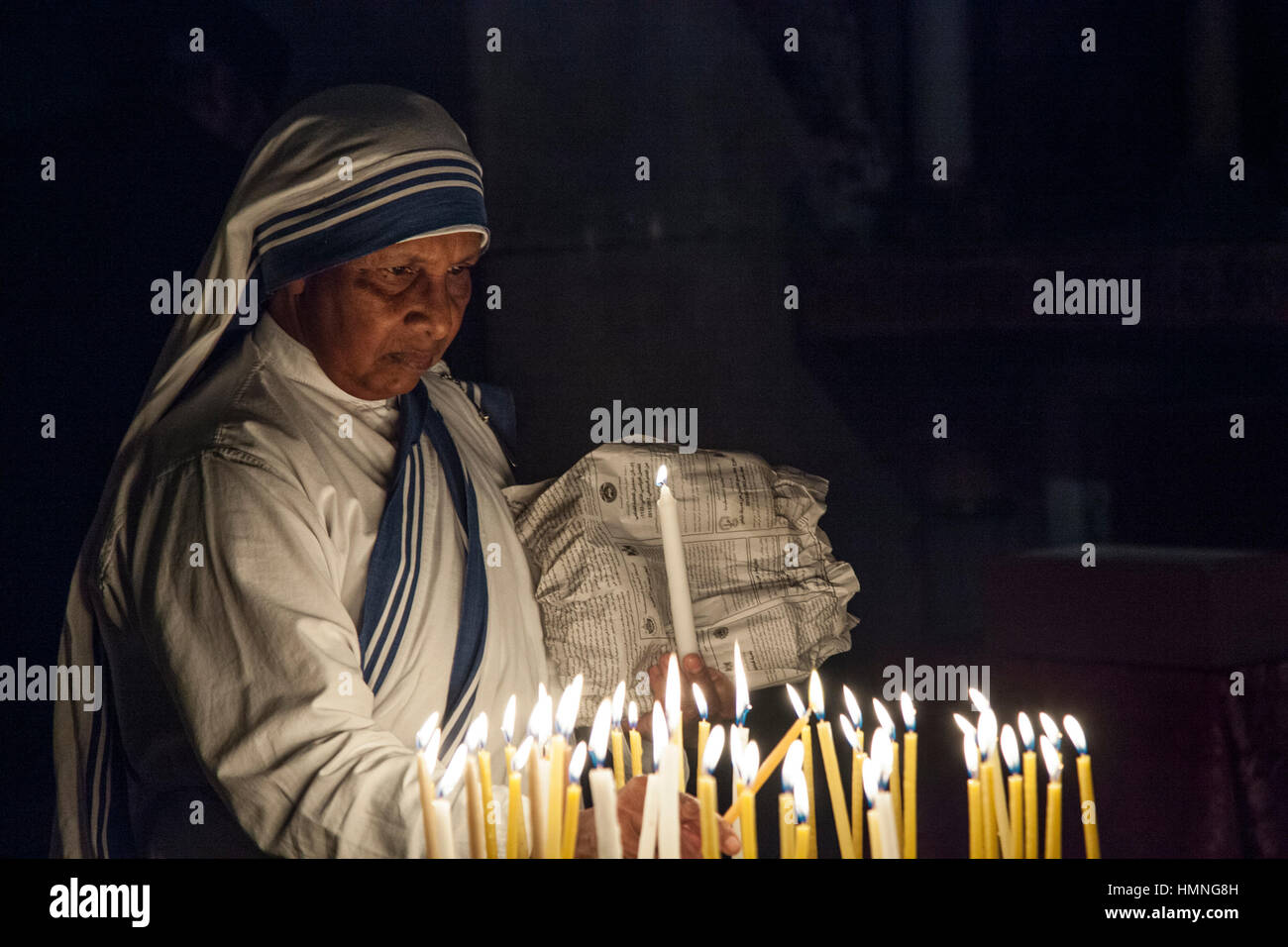 Jerusalem, Israel - October 27, 2013: Latin catholic nun lights a ...