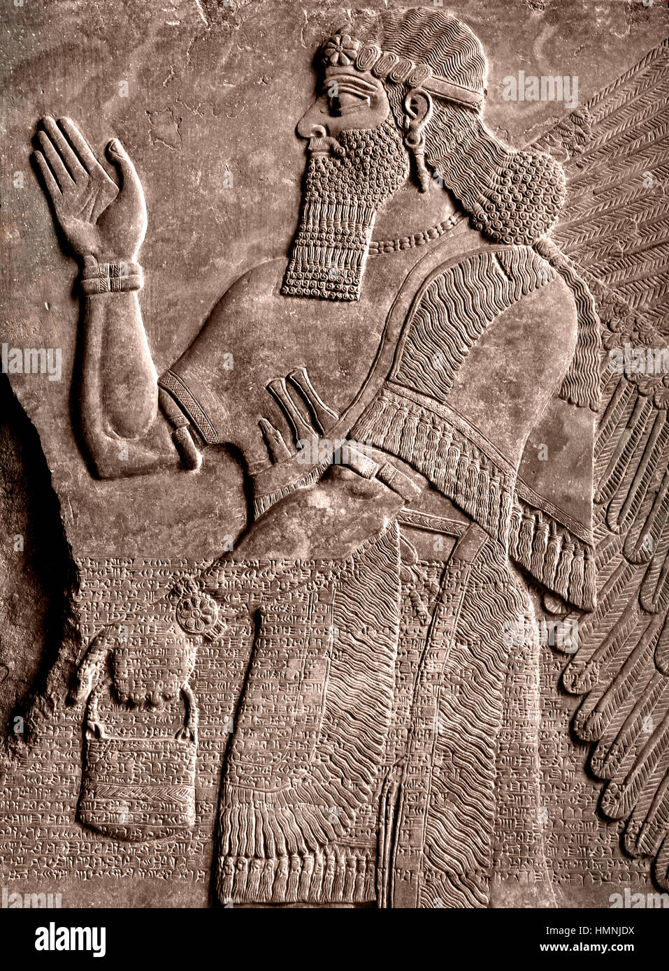 1. CaptionNeo-Assyrian stone relief of a winged genie (apkallu) holding ...