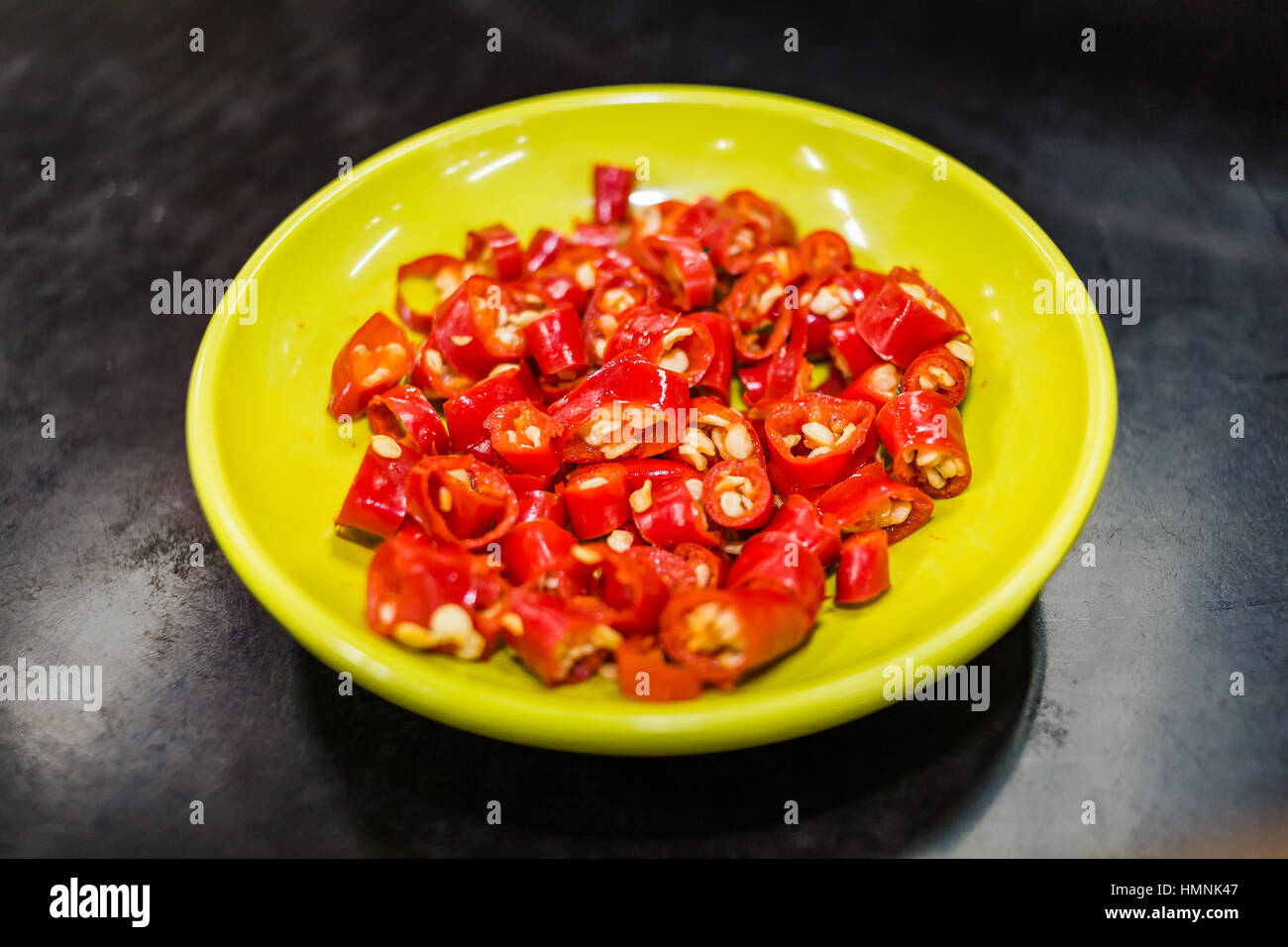 Sliced Chili, Red hot Chili slice, Spicy Thai Chili in yellow plate on ...