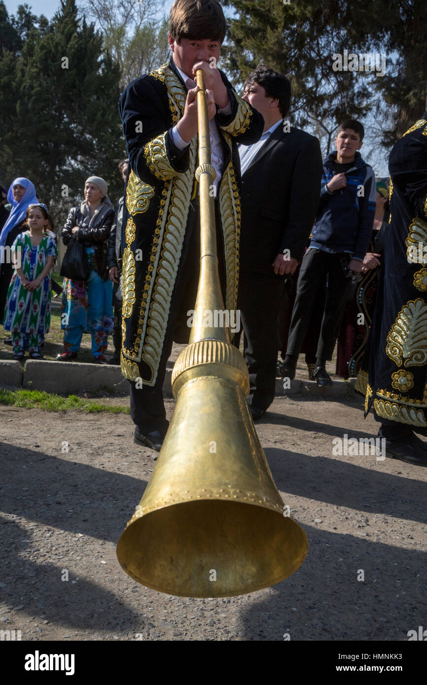 Tajik musician plays on traditional musical instruments karnay during ...