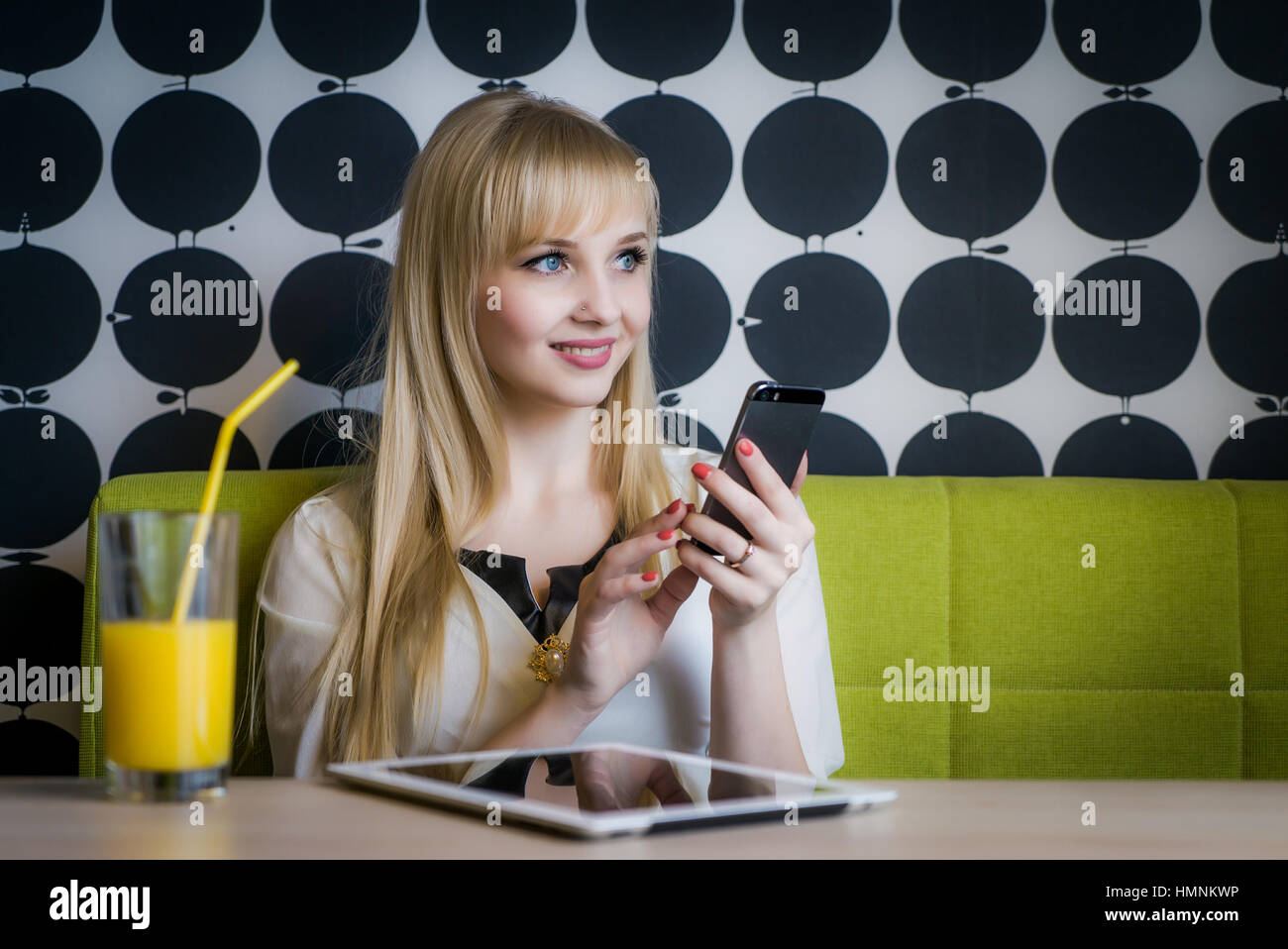 Young student girl drinking orange juice Stock Photo - Alamy