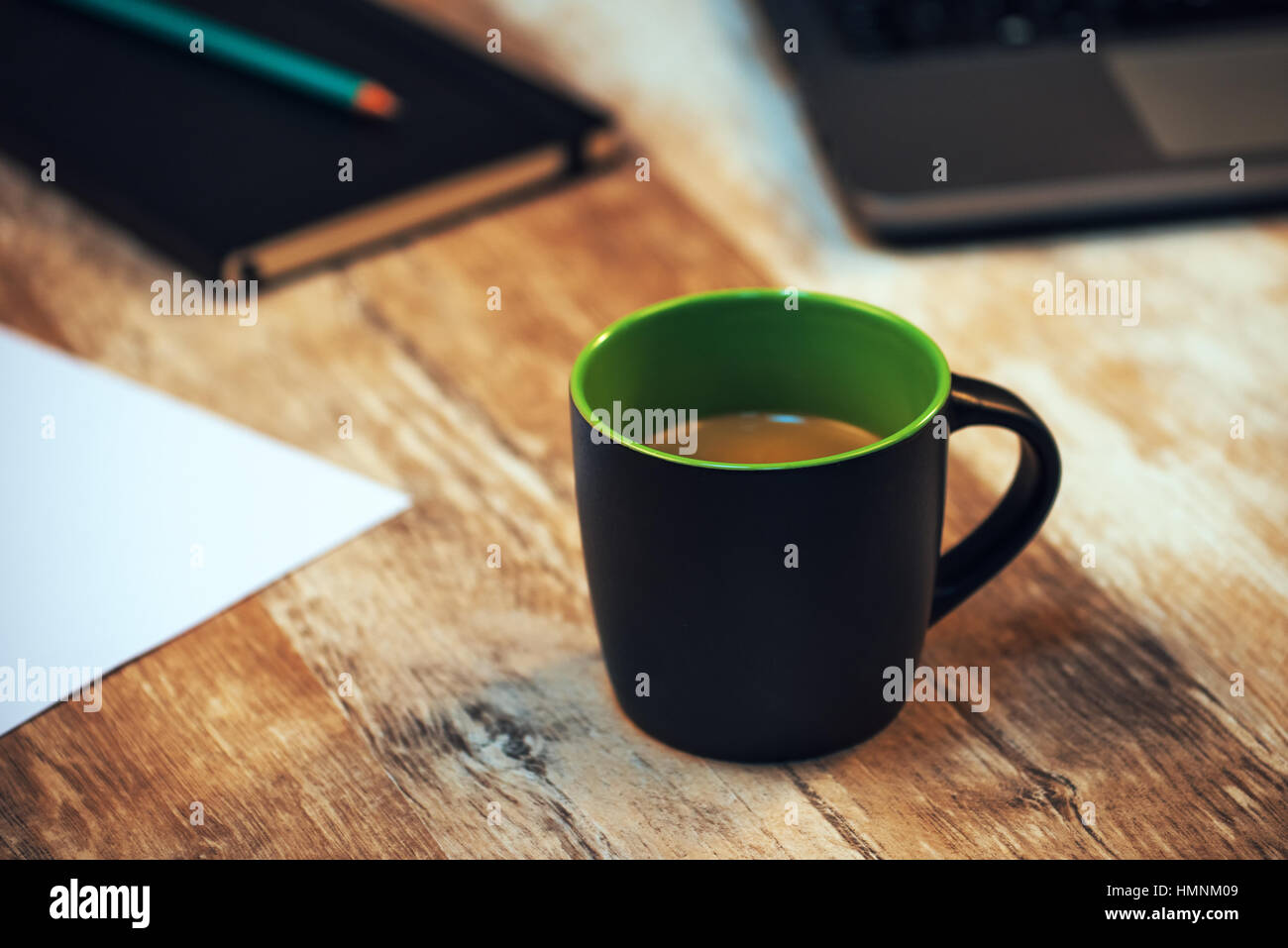 Coffee break. Black coffee cup on office desk with laptop computer and ...
