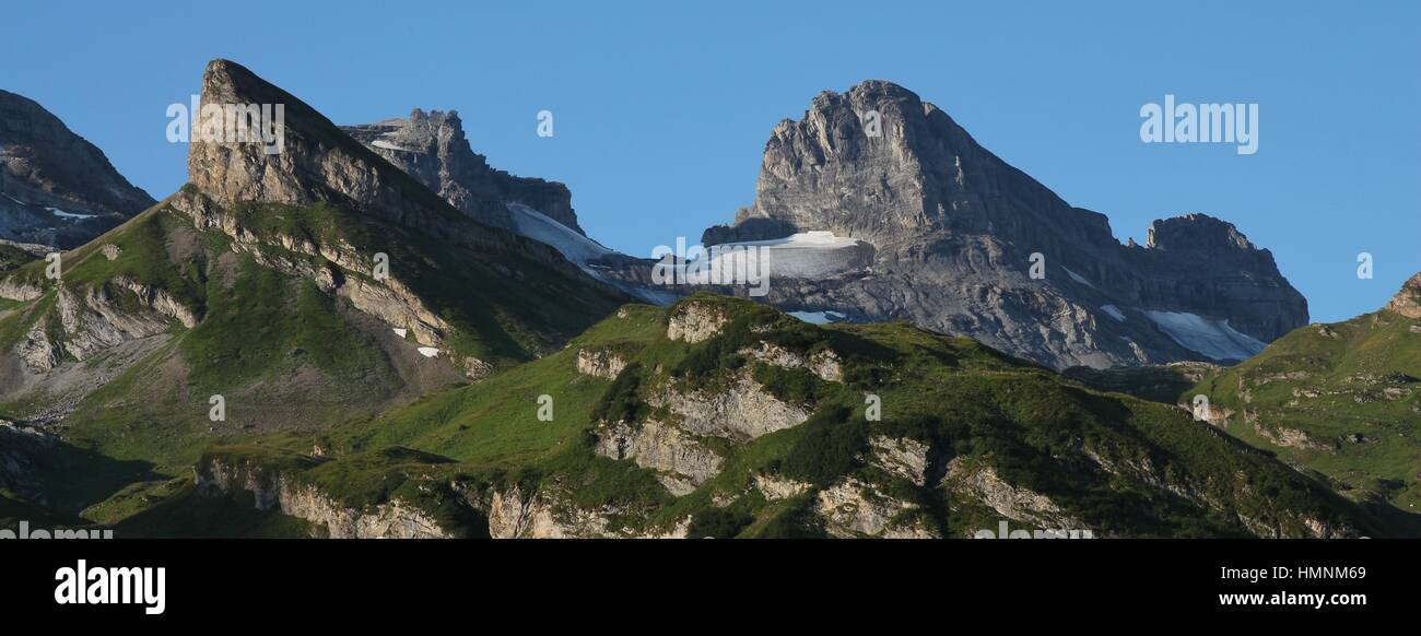 Green meadows, mountains and glacier in Engelberg, Switzerland. Summer ...