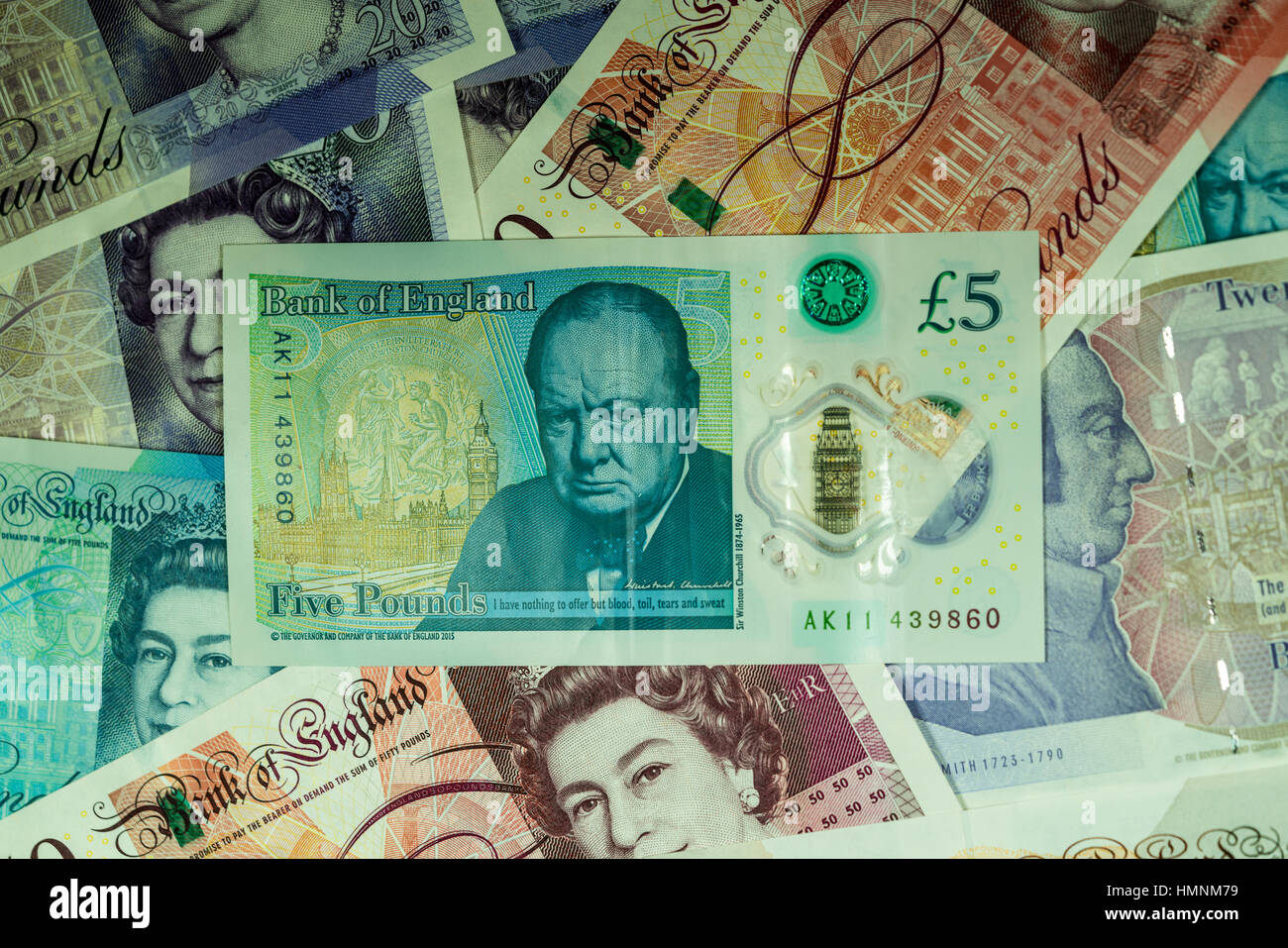 Five (5) pound UK banknote on a background of sterling banknotes ...