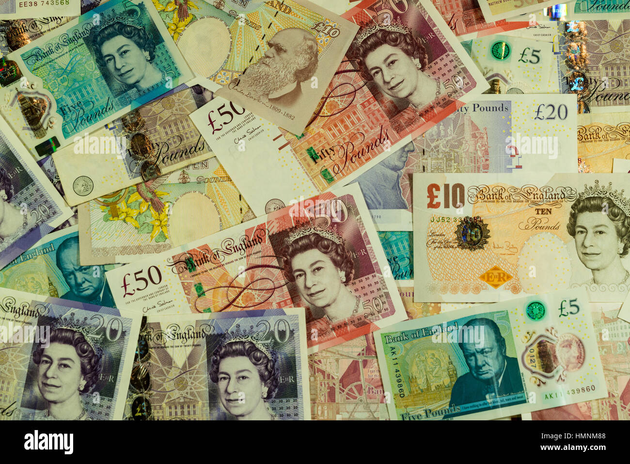 UK pound sterling banknotes scattered Stock Photo - Alamy