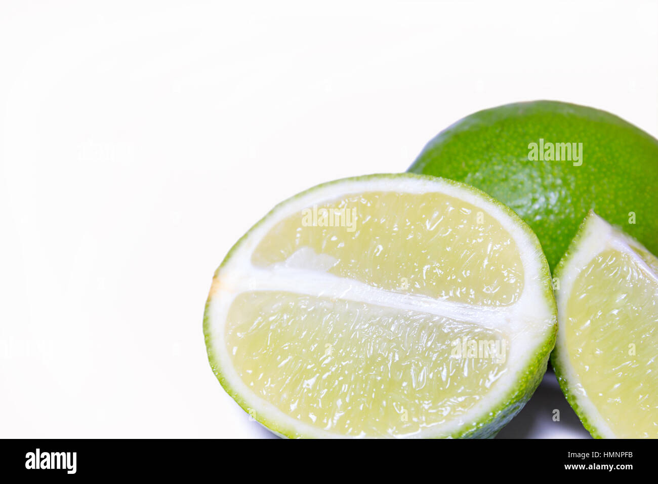 Sliced Fresh lime fruit isolated on white background Stock Photo - Alamy