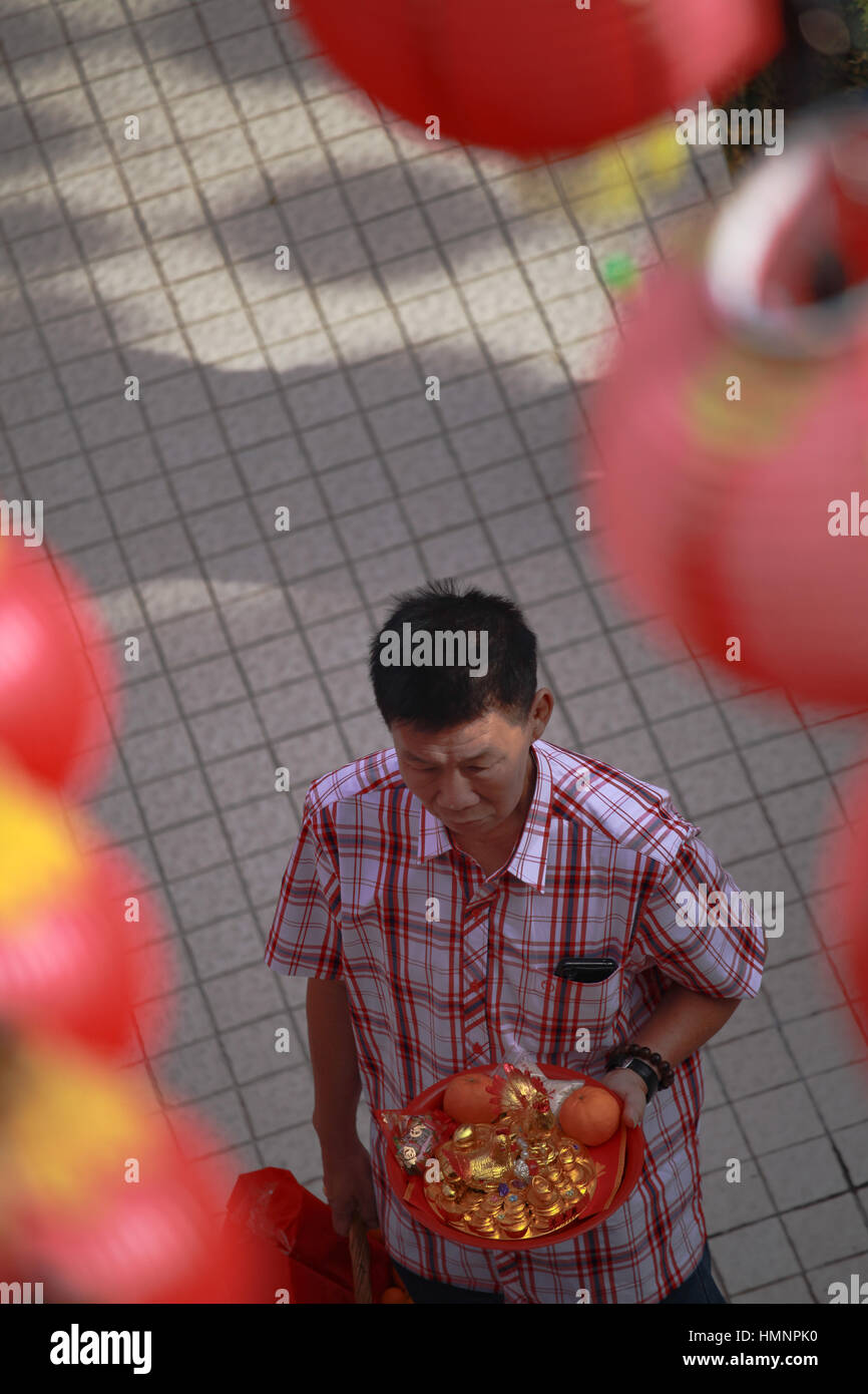 Kuala Lumpur, Malaysia - JANUARY 28, 2017. Man holding praying stuff ...