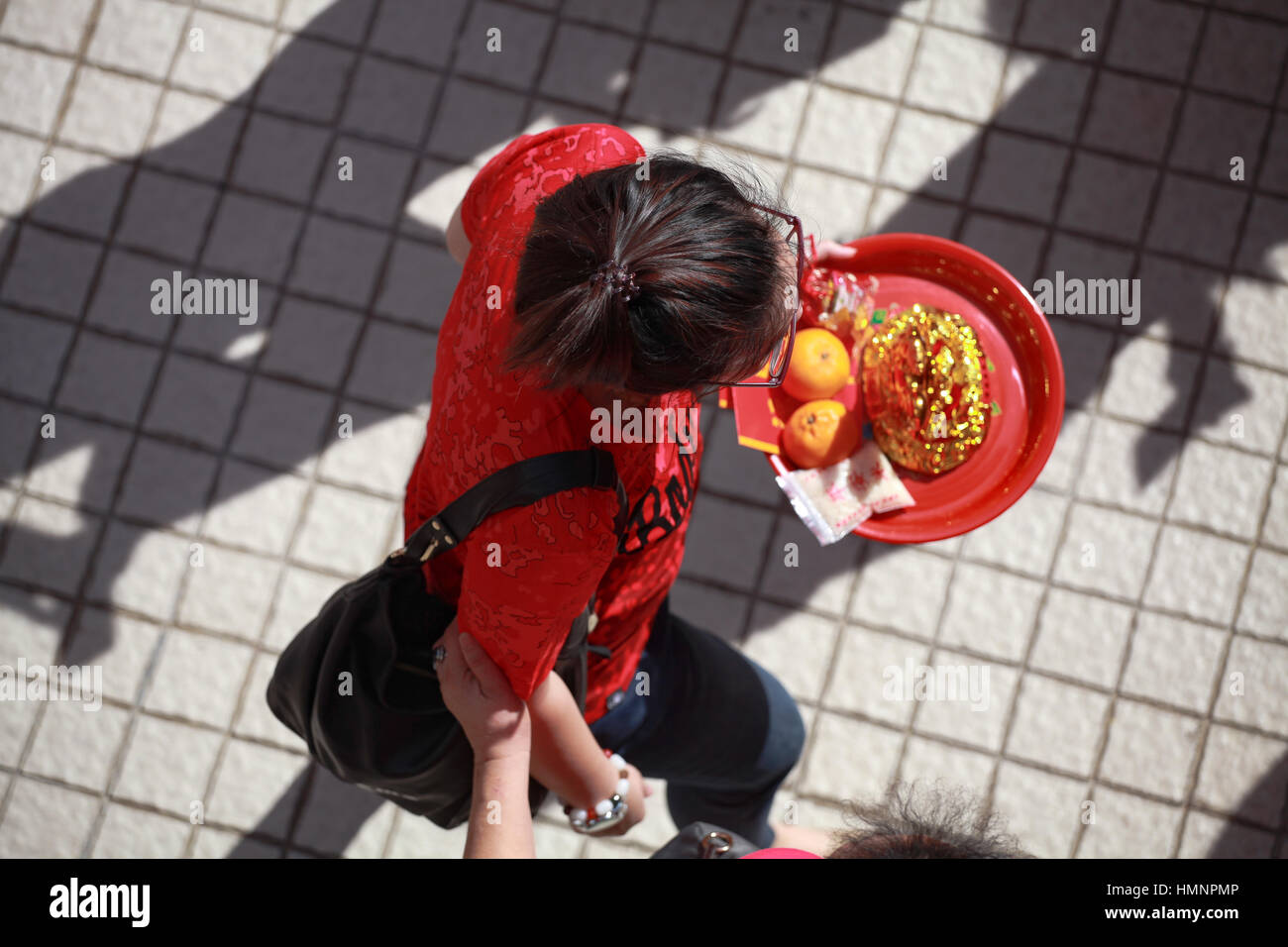 Kuala Lumpur, Malaysia - JANUARY 28, 2017. Woman holding praying stuff ...
