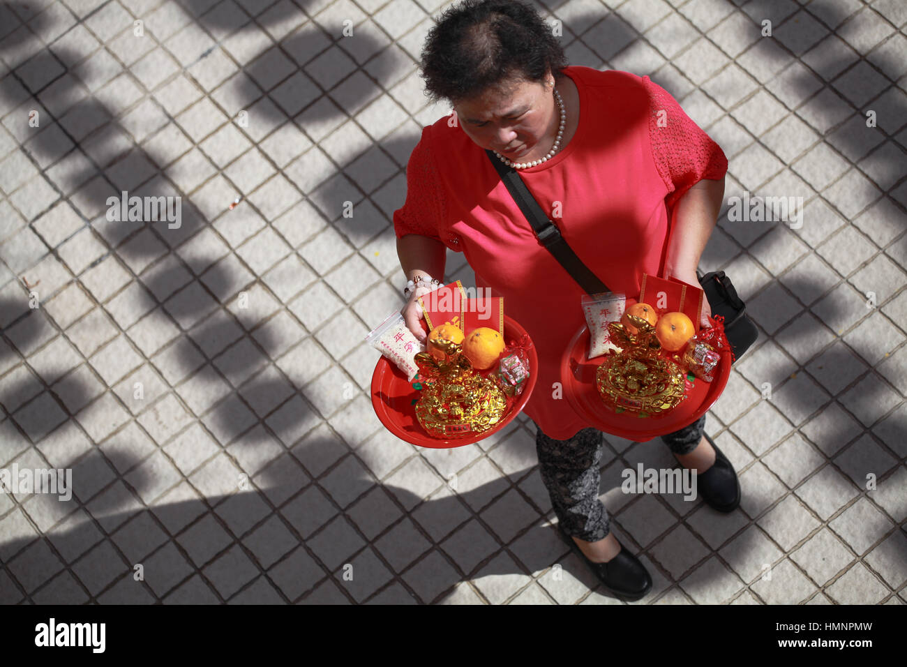 Kuala Lumpur, Malaysia - JANUARY 28, 2017. Woman holding praying stuff ...